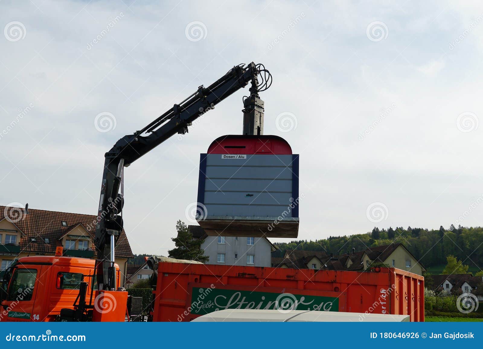 Working Machine Positioning a Container for Separated Waste in Order To ...