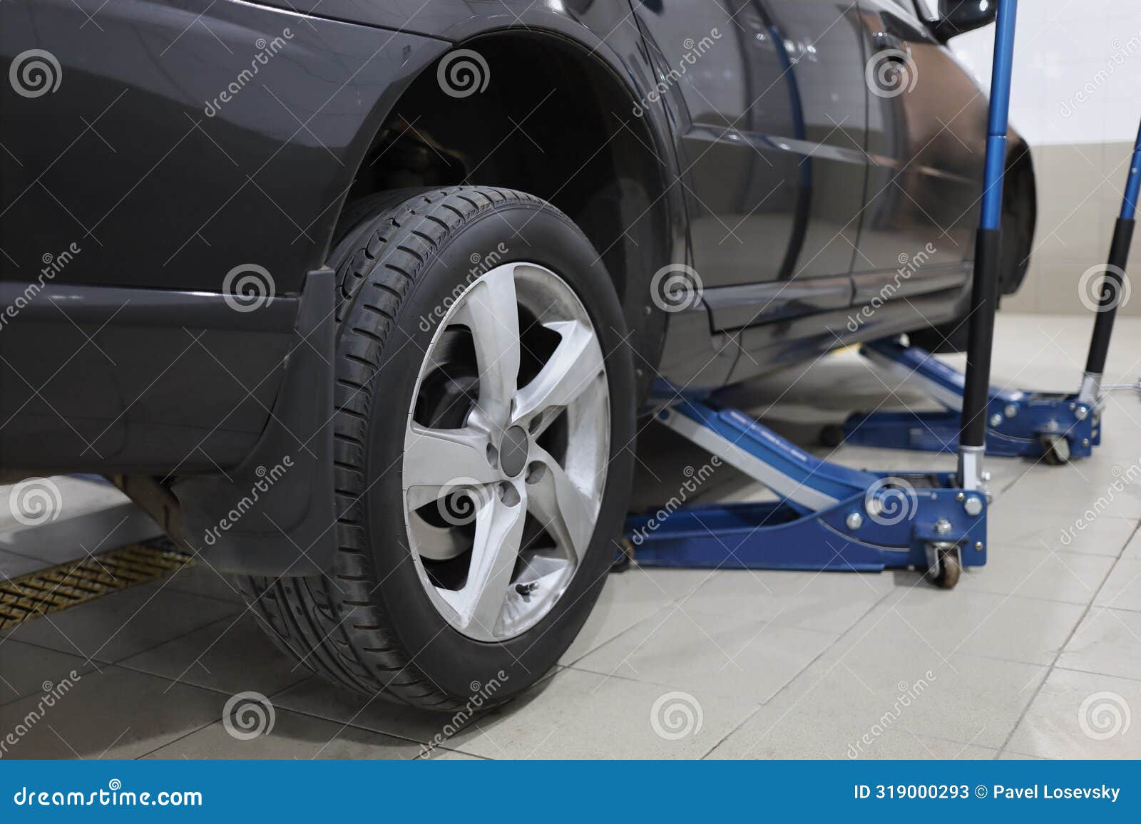 Hydraulic Floor Jacks Under a Black Car in a Car Stock Image - Image of ...