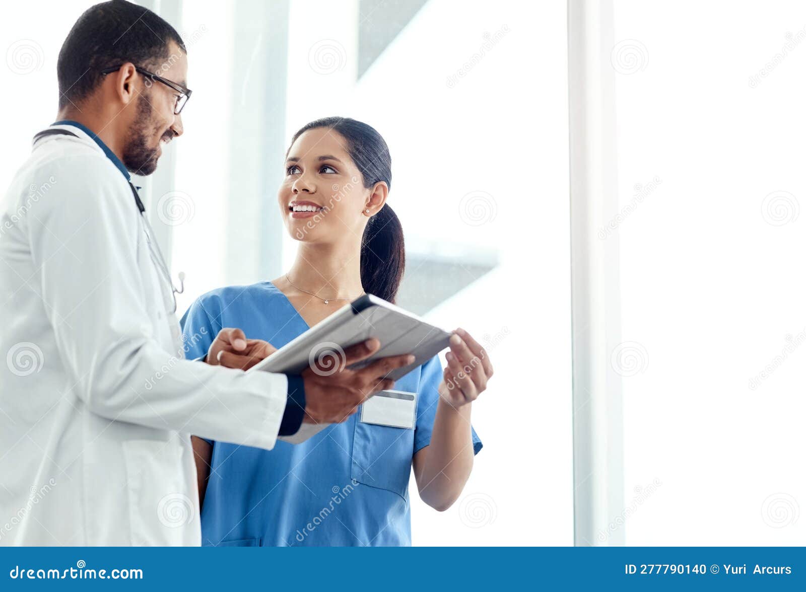 I always Appreciate Your Input. Two Young Doctors Using a Digital ...