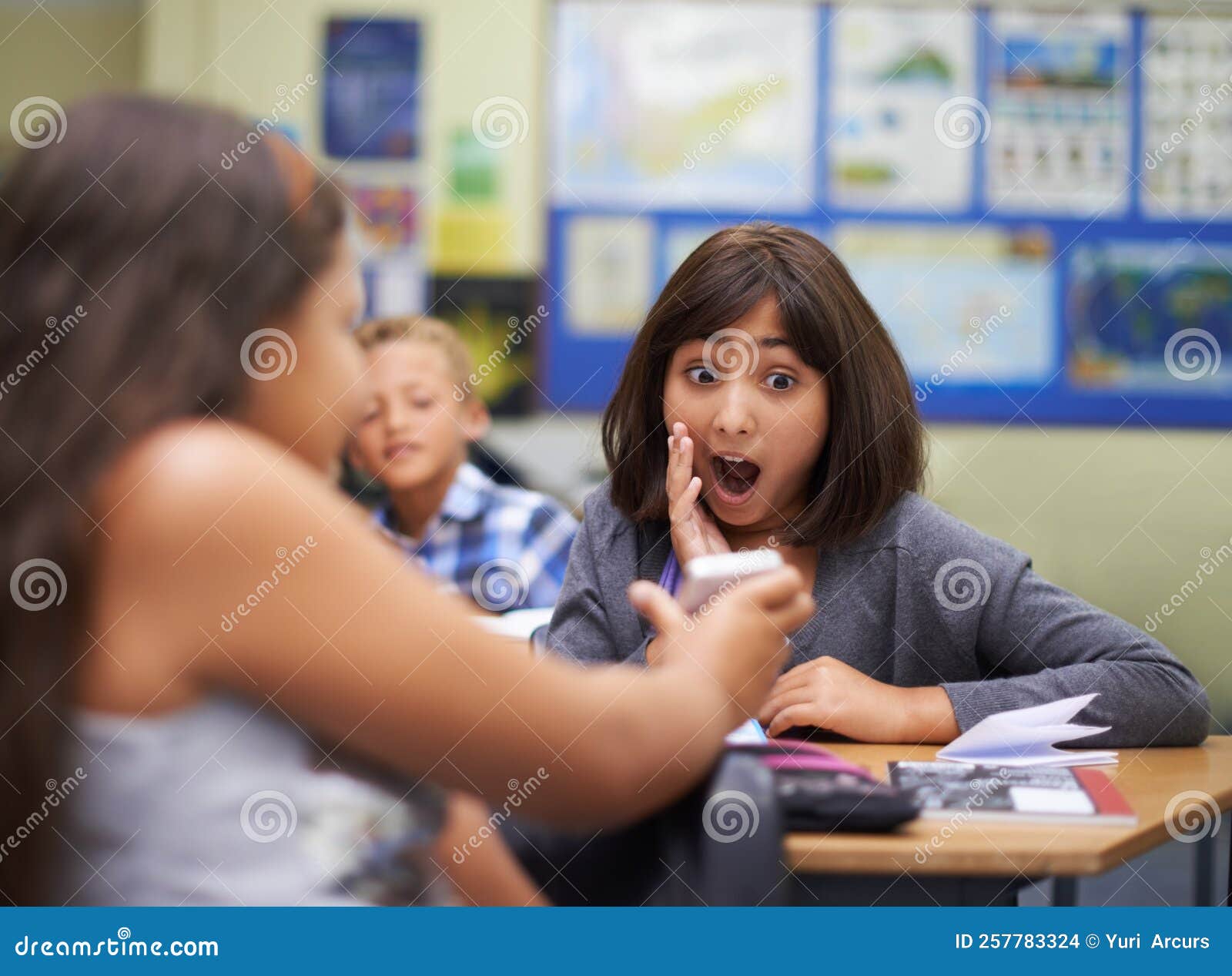 I Cant Believe It A Young Girl Showing Her Classmate Something On Her