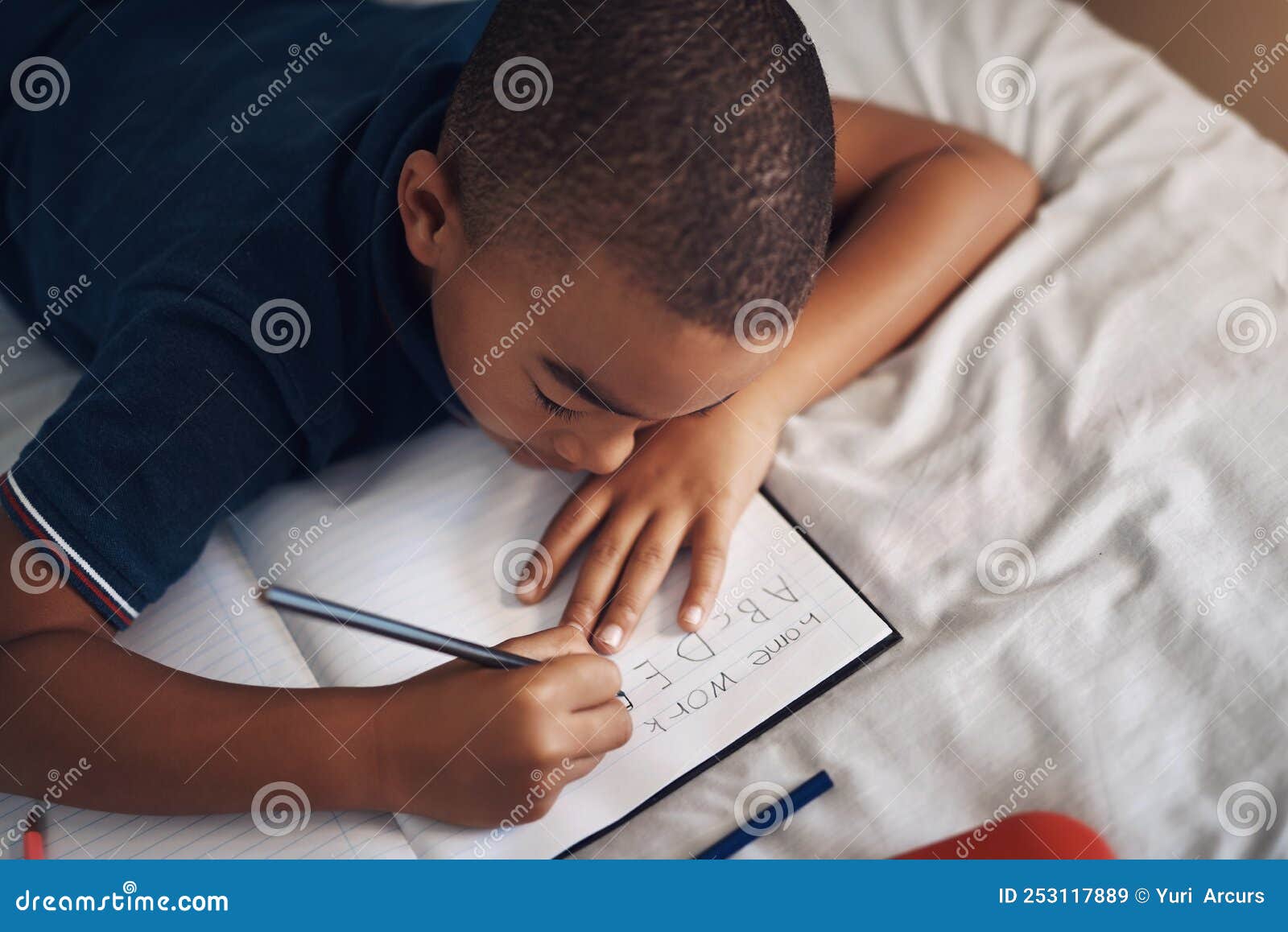 I Think that Doing Homework is Fun. a Young Boy Using a Pencil while ...