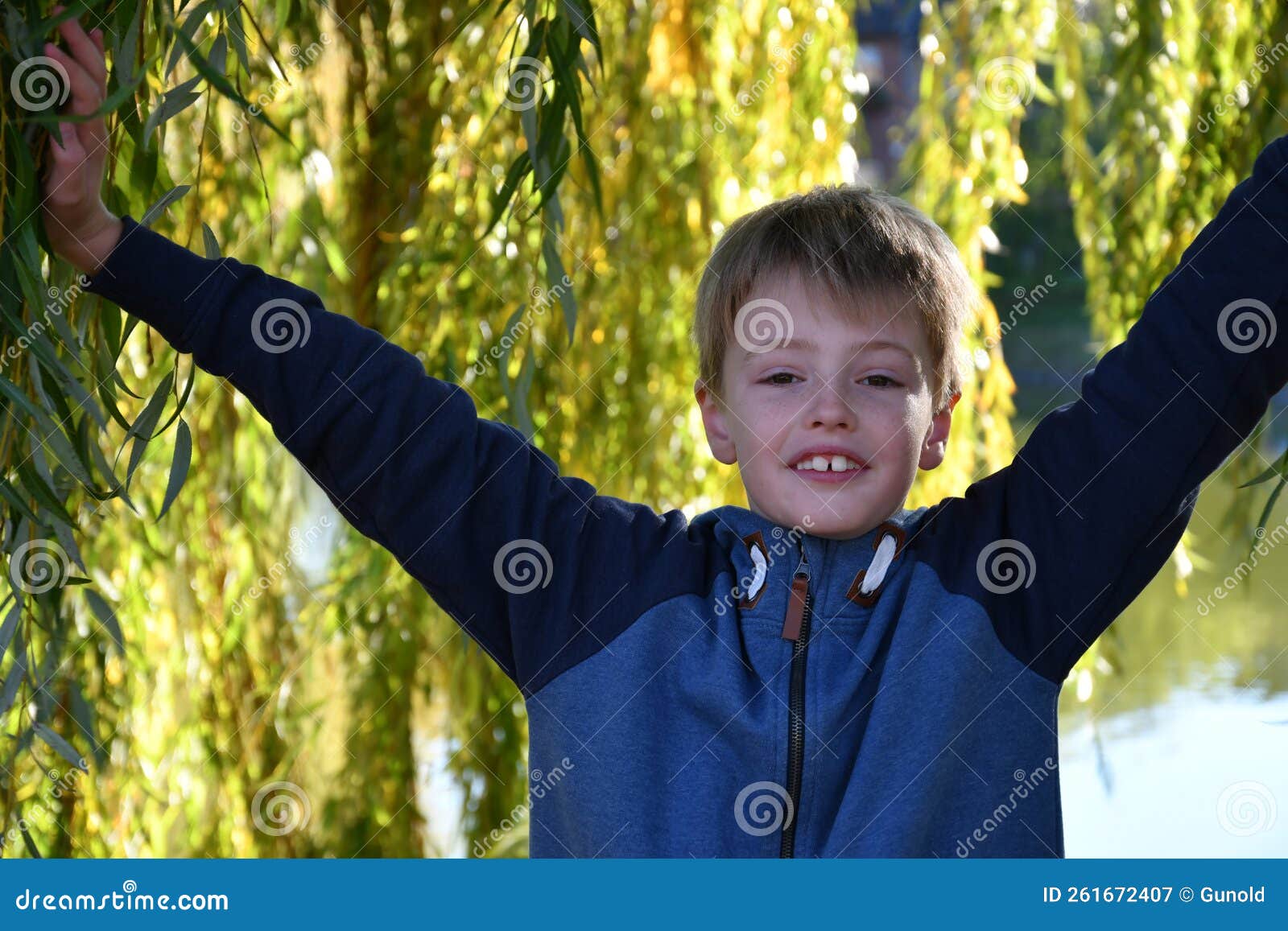 Cheering Boy in Front of a Weeping Willow Tree Stock Image - Image of ...