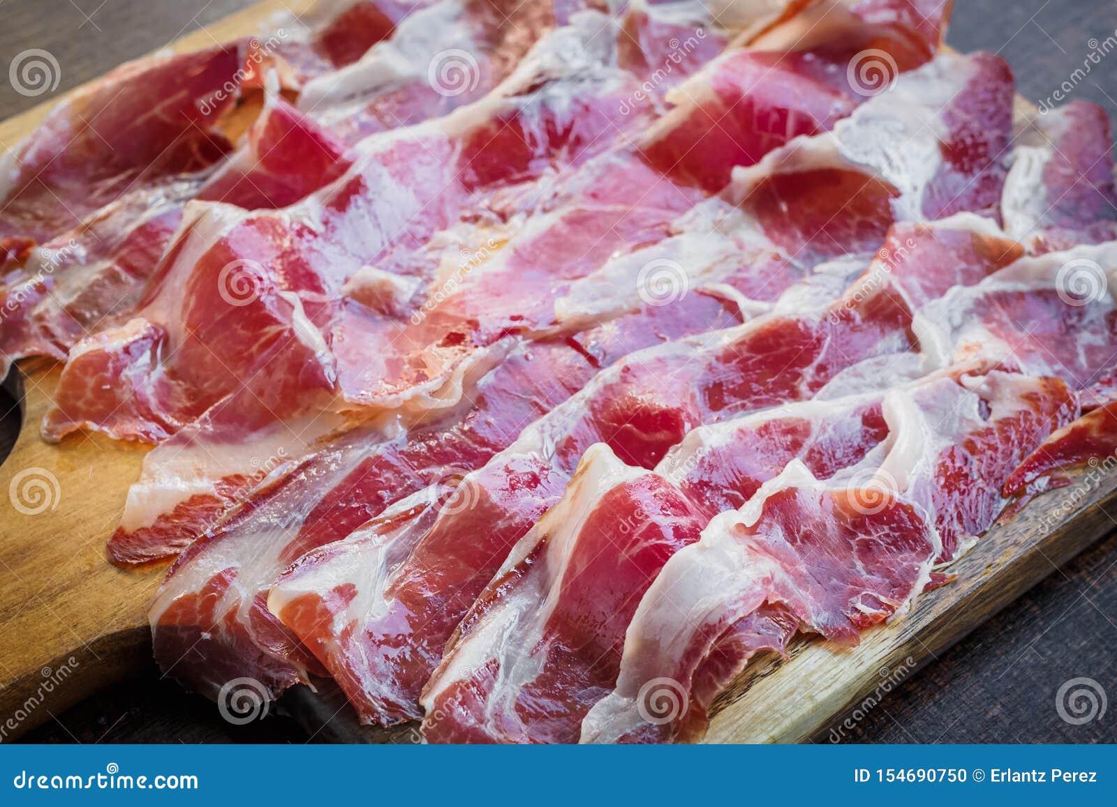 Iberico Ham Cut on a Wooden Board Stock Photo - Image of lomo, olive ...