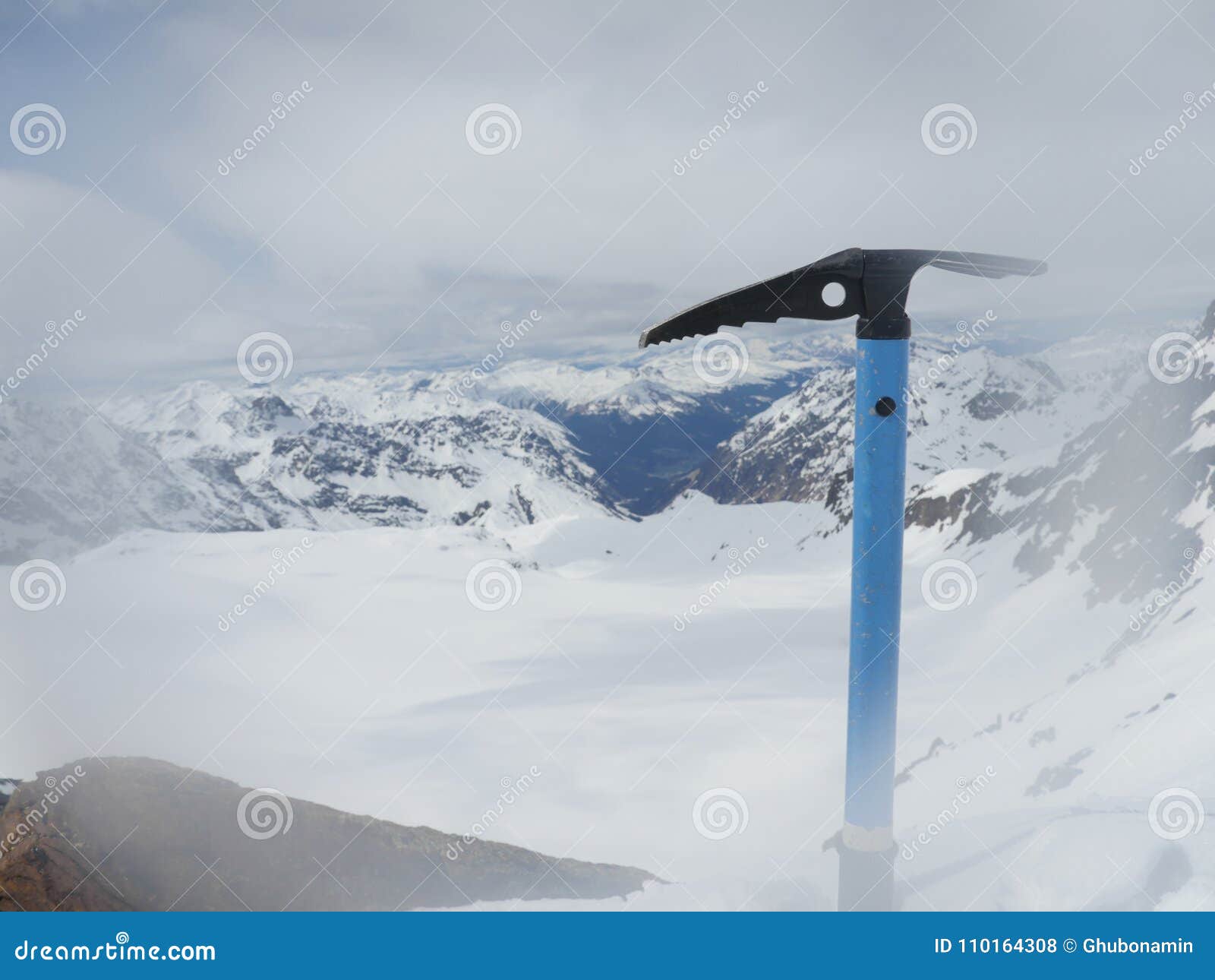 Ice axe in snow stock photo. Image of clouds, equipment - 110164308