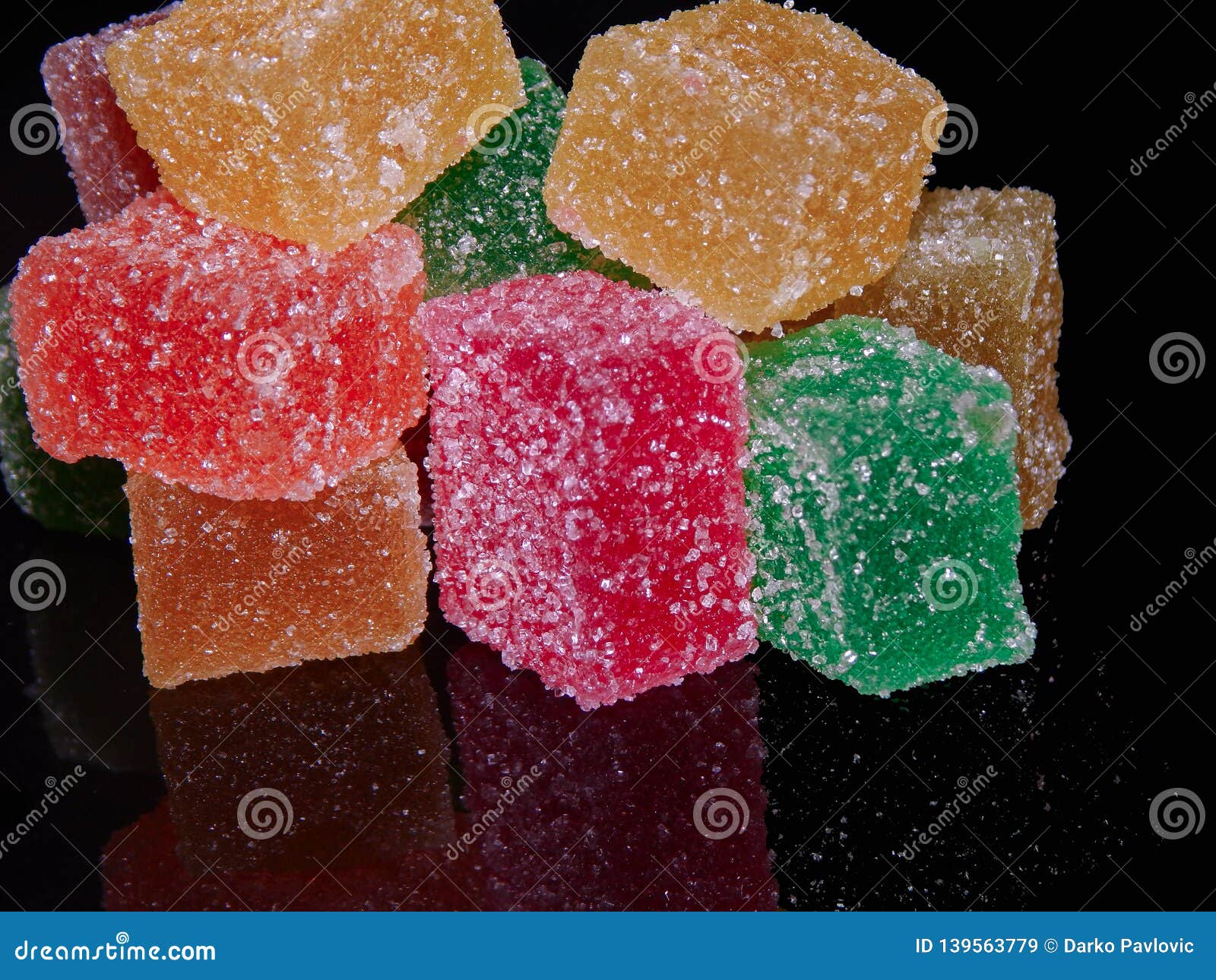 Cubes of Jelly on a Black Reflective Background Stock Image - Image of ...