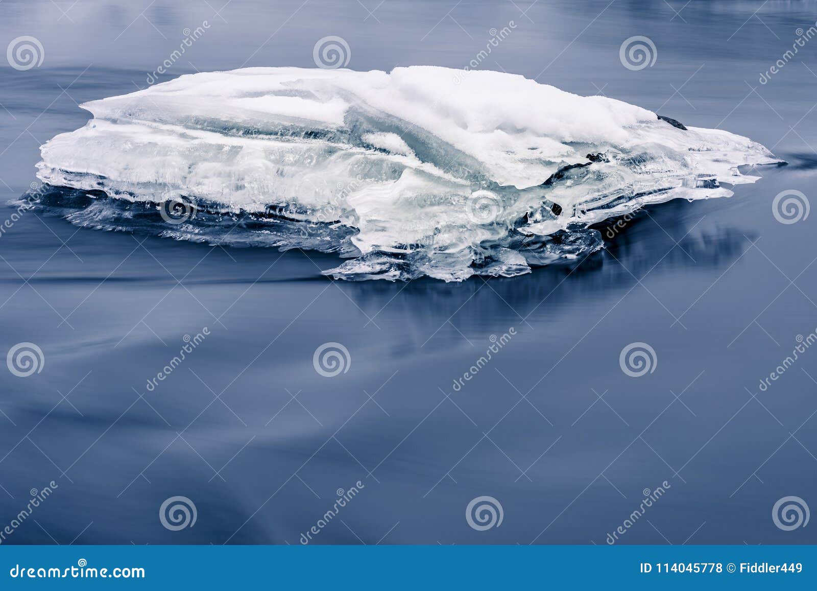 Ice block in blue water stock photo. Image of calm, stream - 114045778