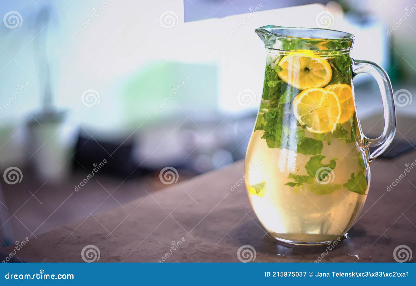 Ice Cold Lemonade with Mint and Lemon. the Pitcher is Standing on the ...