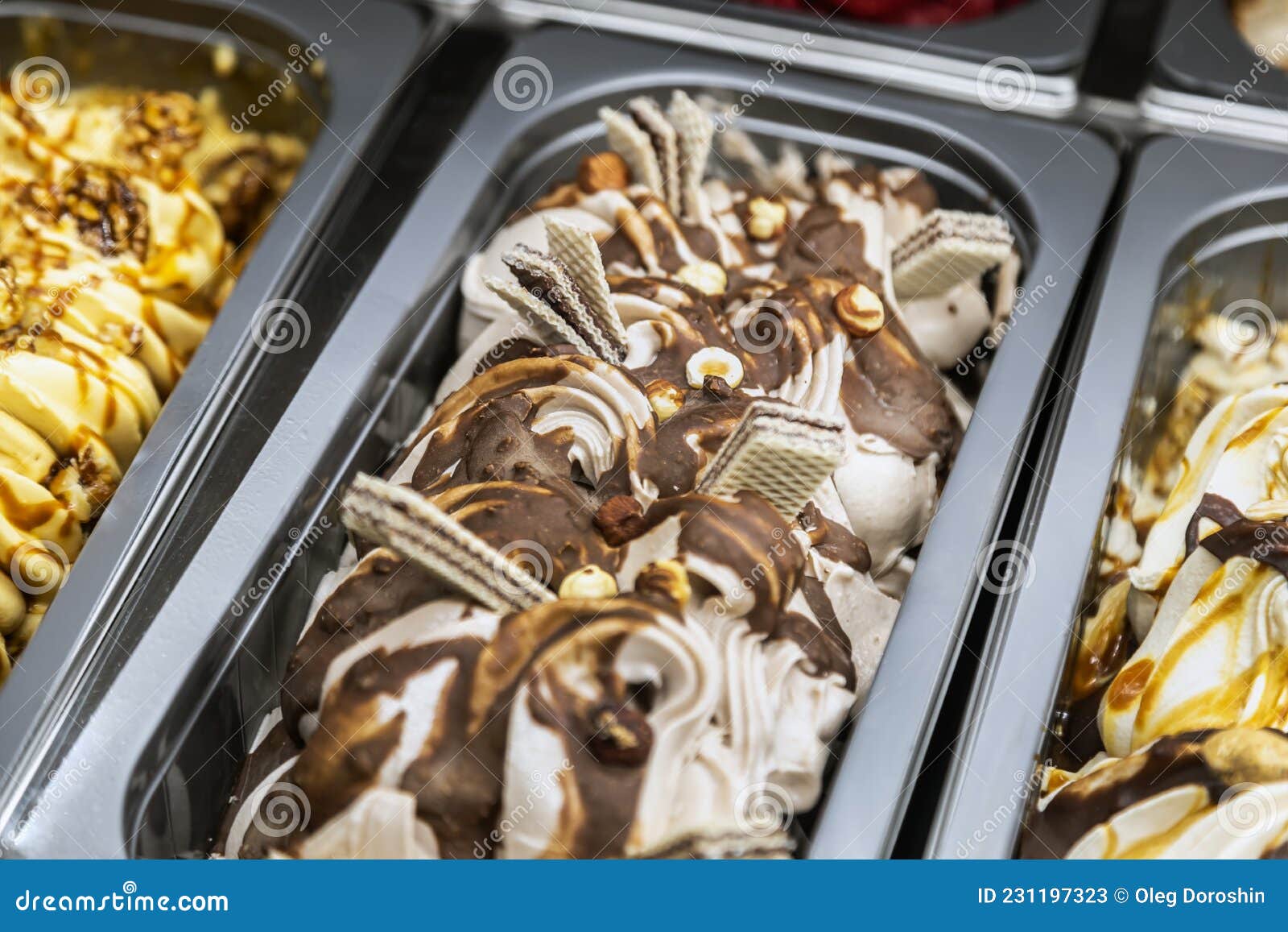 Ice Cream With Different Flavors In Trays In The Refrigerator Stock