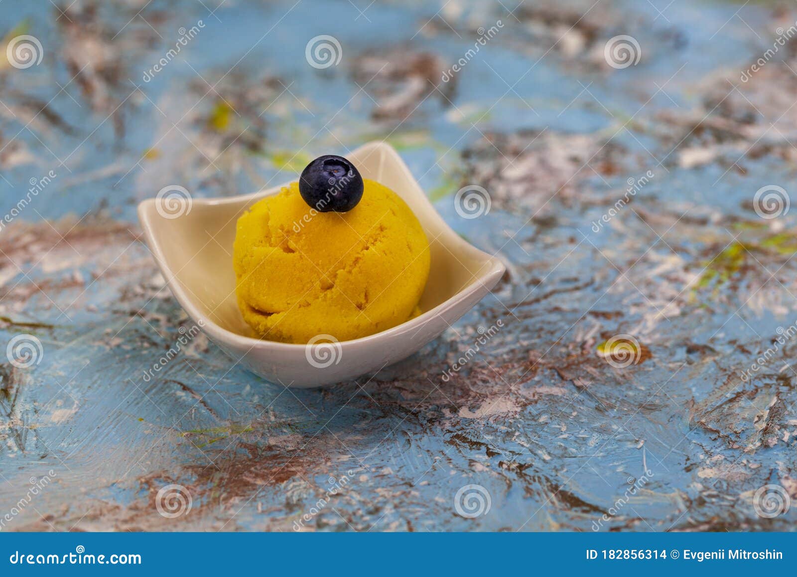 Ice Cream with Mango Pulp, Garnished with Blueberries, on a Blue ...