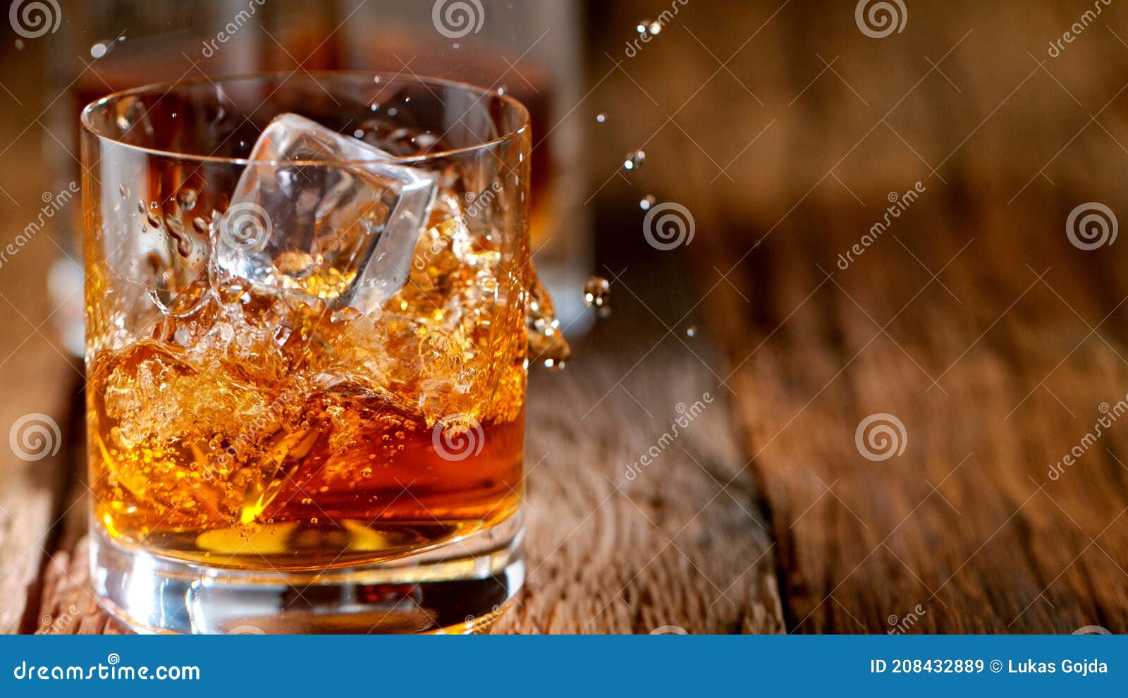 Ice Cube Falling into Glass of Whisky Stock Image - Image of alcohol ...