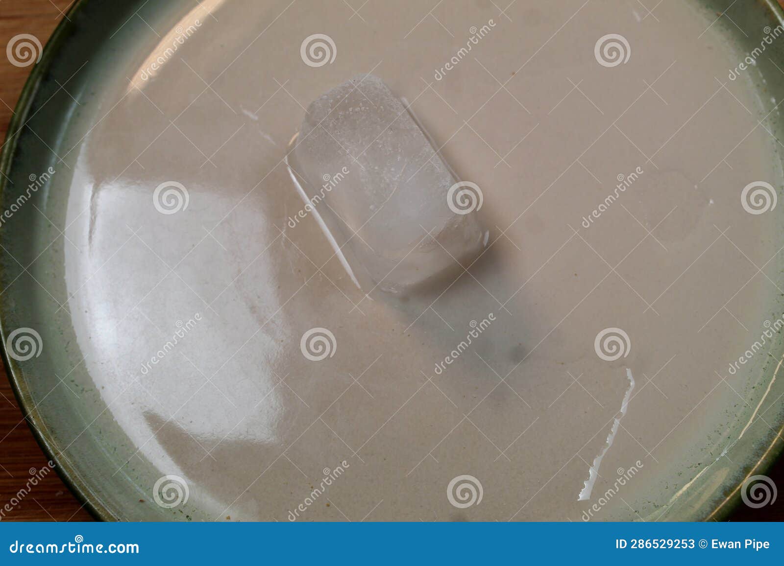 Ice cube melting on plate stock image. Image of design - 286529253
