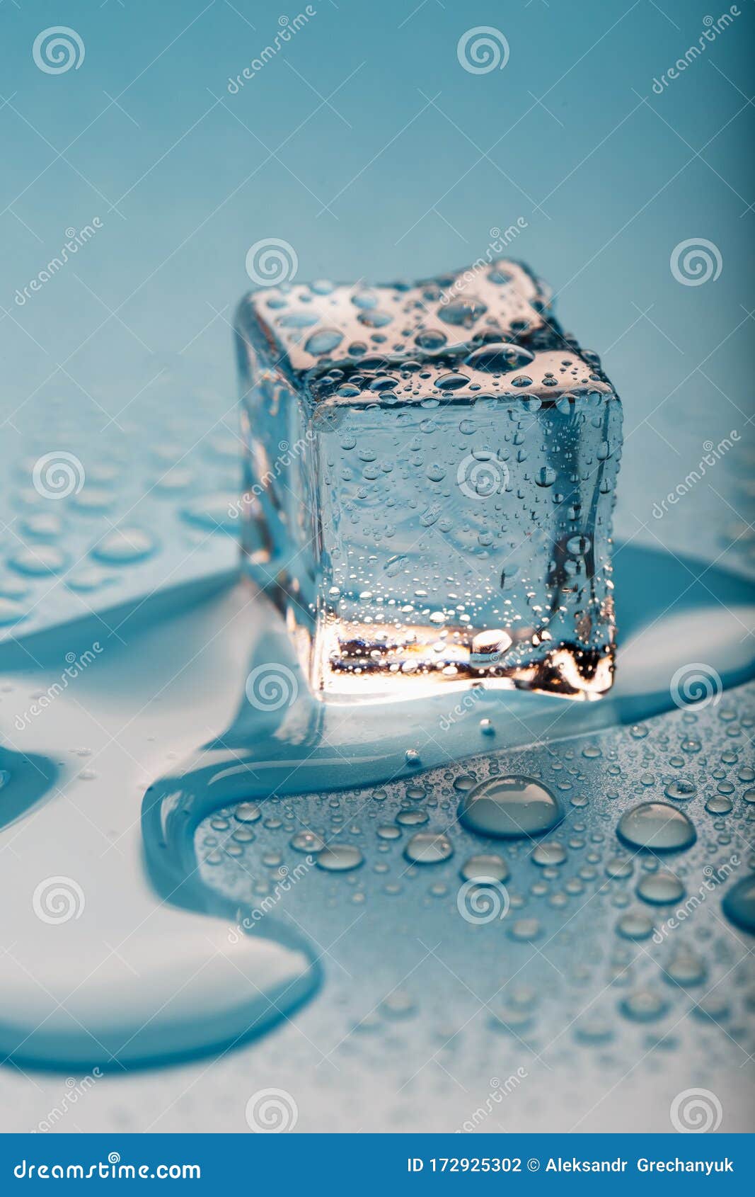 Ice Cube with Water Drops on a Blue Background. the Ice is Melting ...
