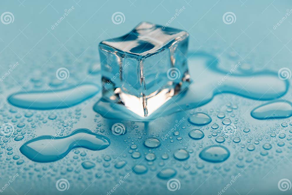 Ice Cube with Water Drops on a Blue Background. the Ice is Melting ...