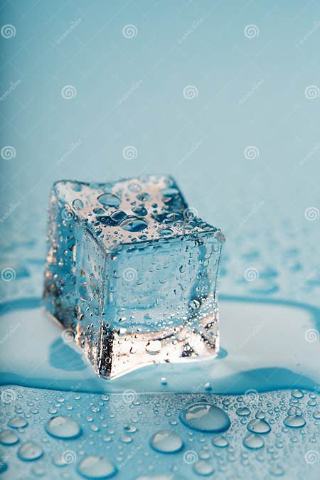 Ice Cube with Water Drops on a Blue Background. the Ice is Melting ...