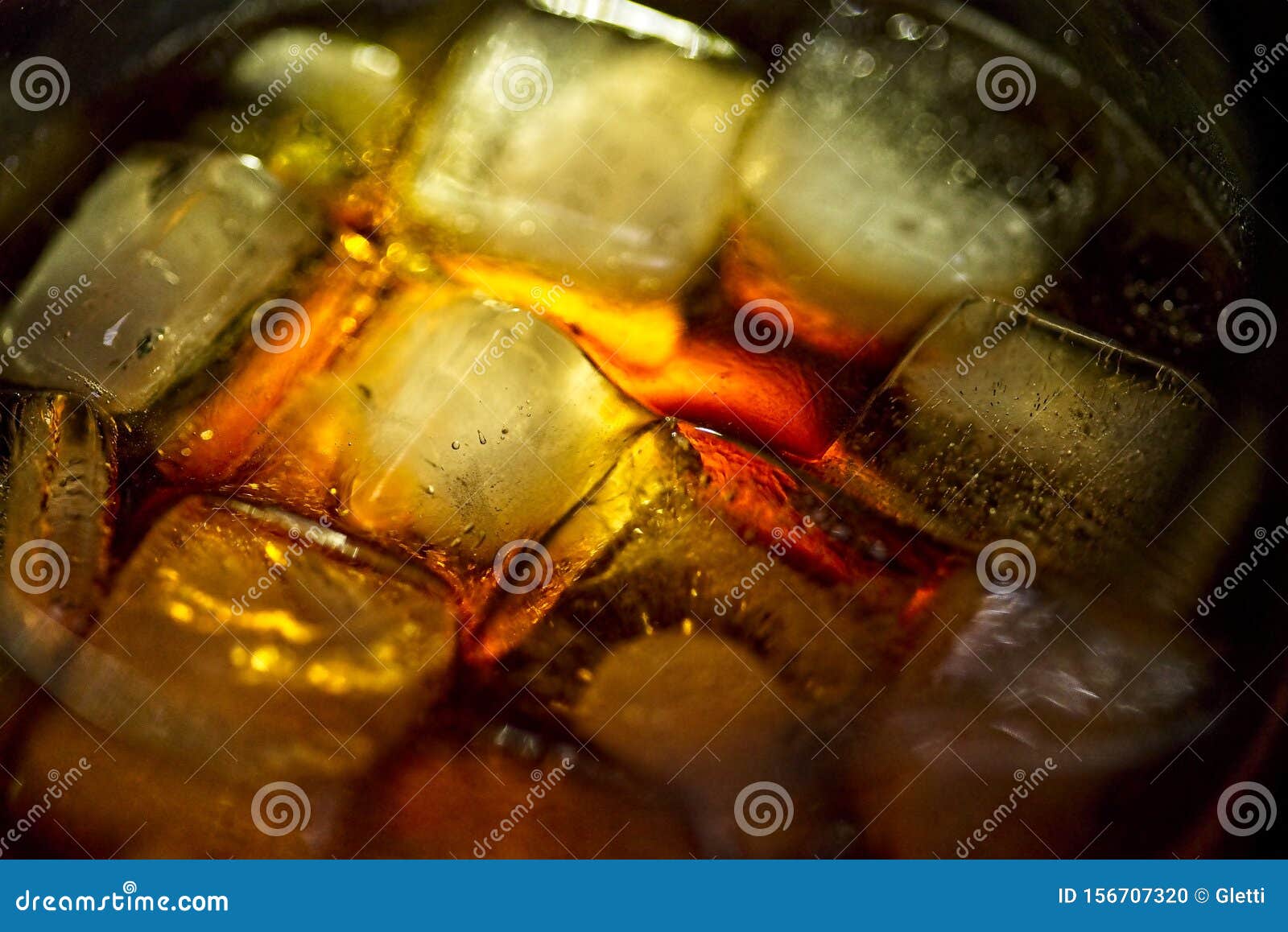Ice cubes in brown liquid stock photo. Image of brown - 156707320