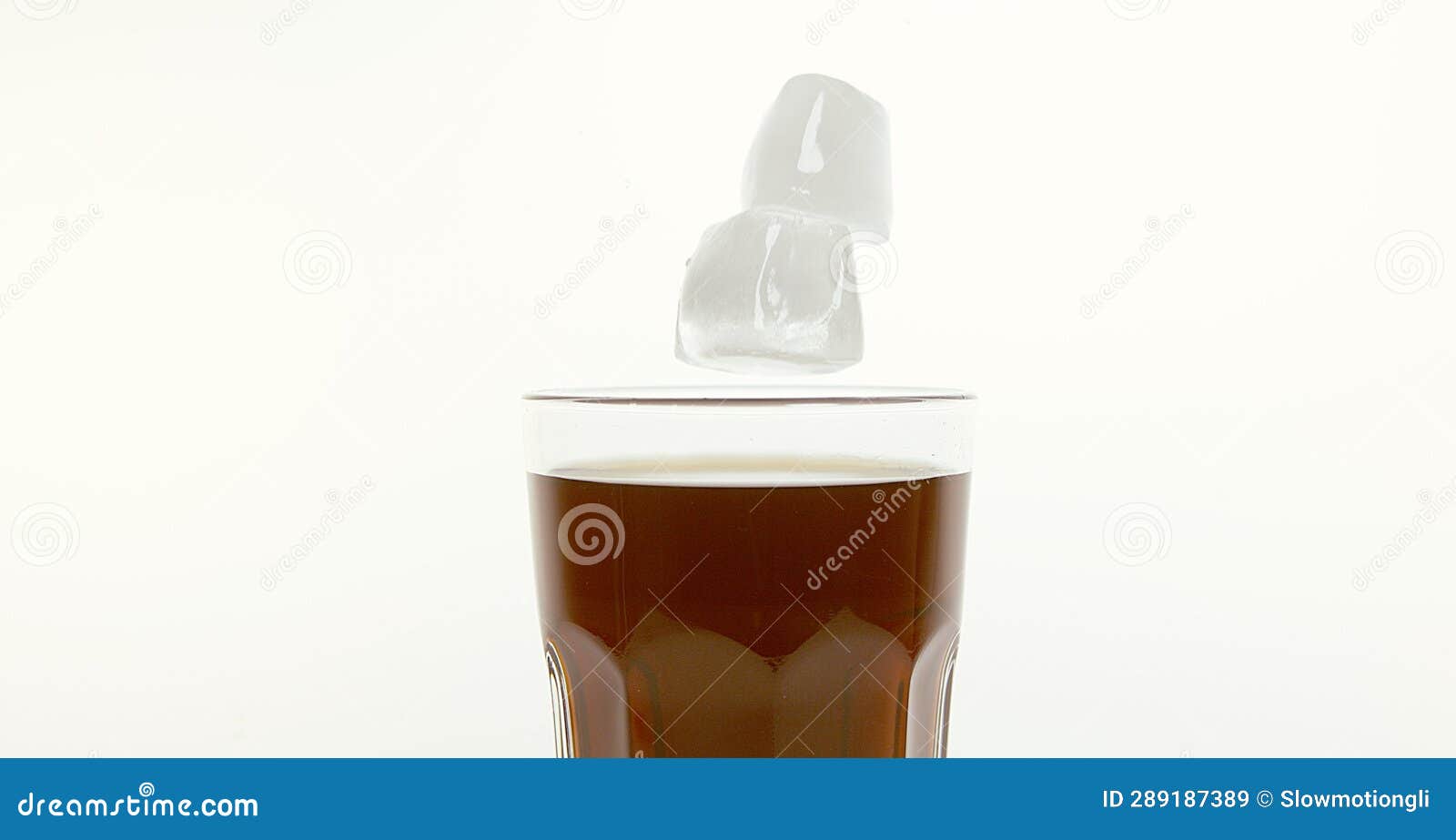 Ice Cubes Falling into Glass of Coke Against White Background Stock ...