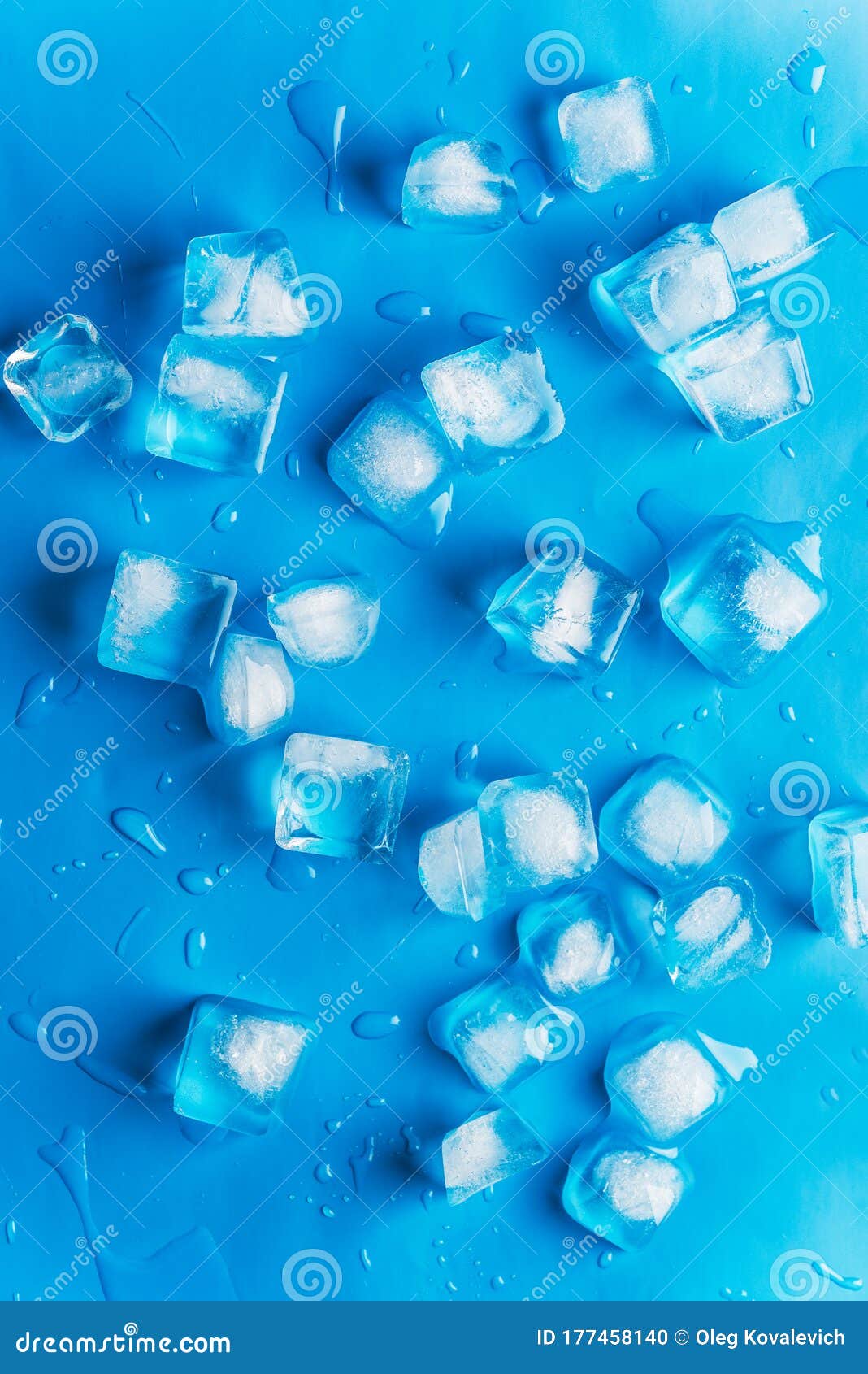 Ice Cubes and Water Drops Scattered on Blue Background Stock Photo ...