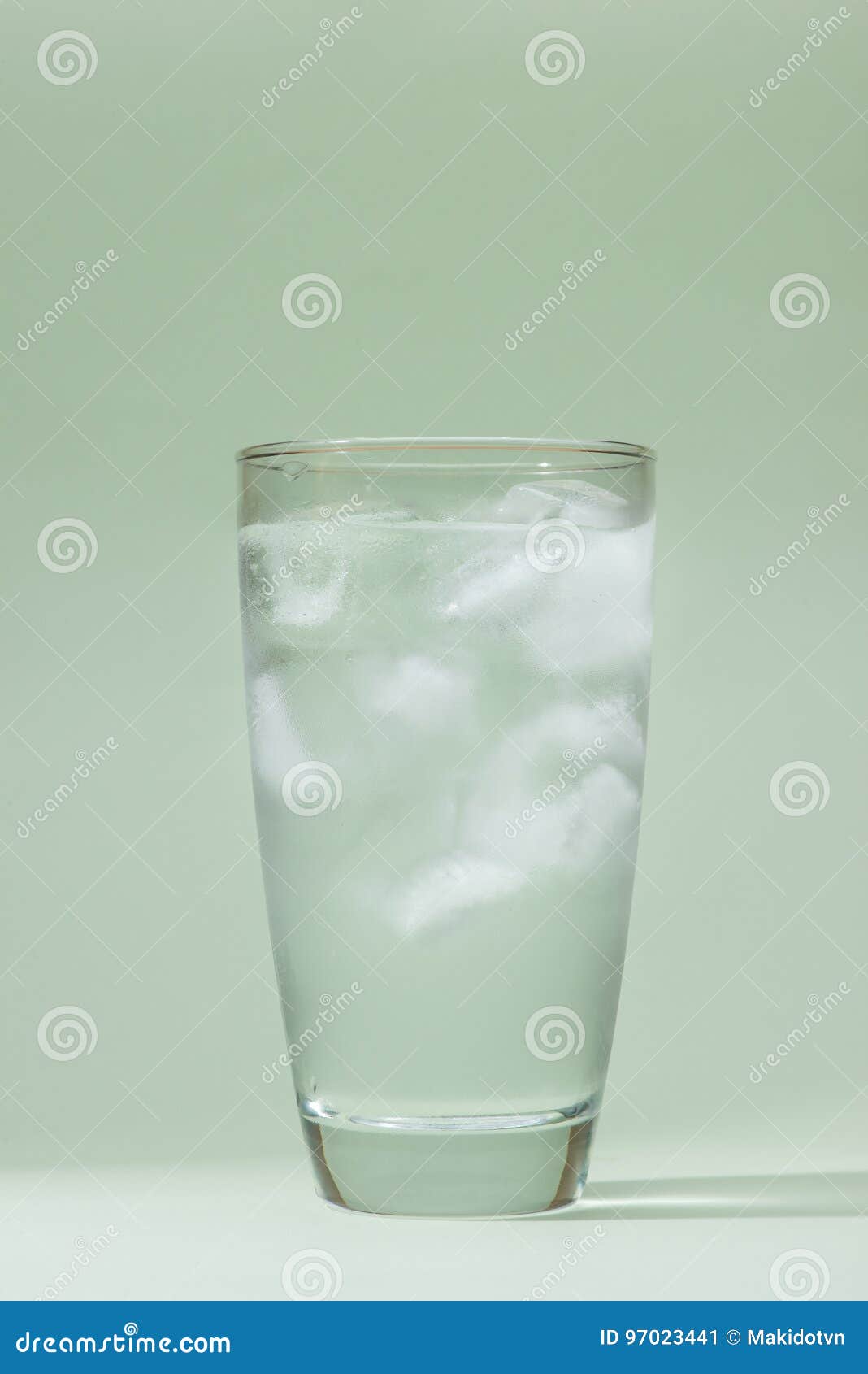 Ice Drinking Water Glass on Table Over Green. Stock Image - Image of ...