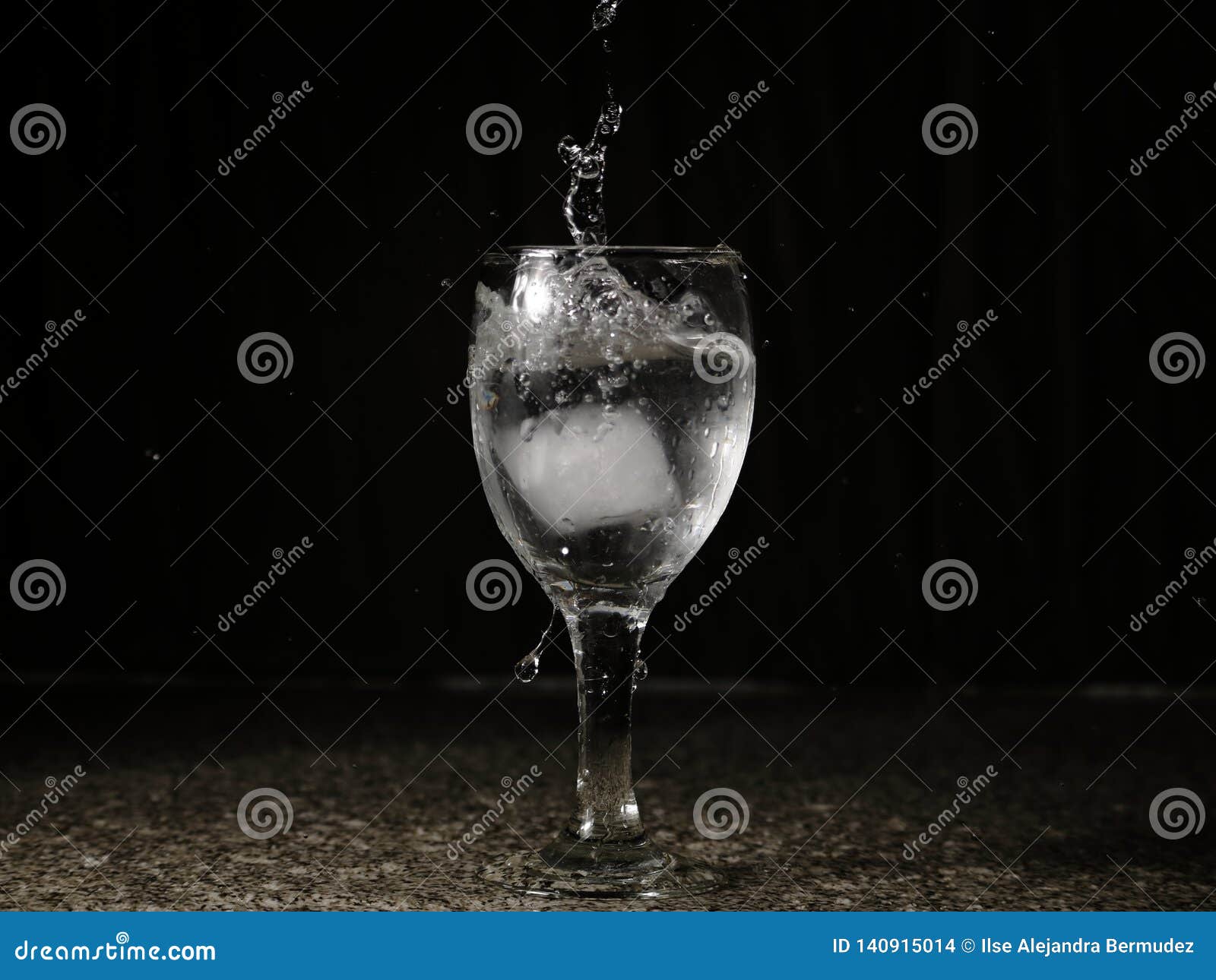 Ice Falling on a Glass with Drink that Spills and Splashes. Stock Photo ...
