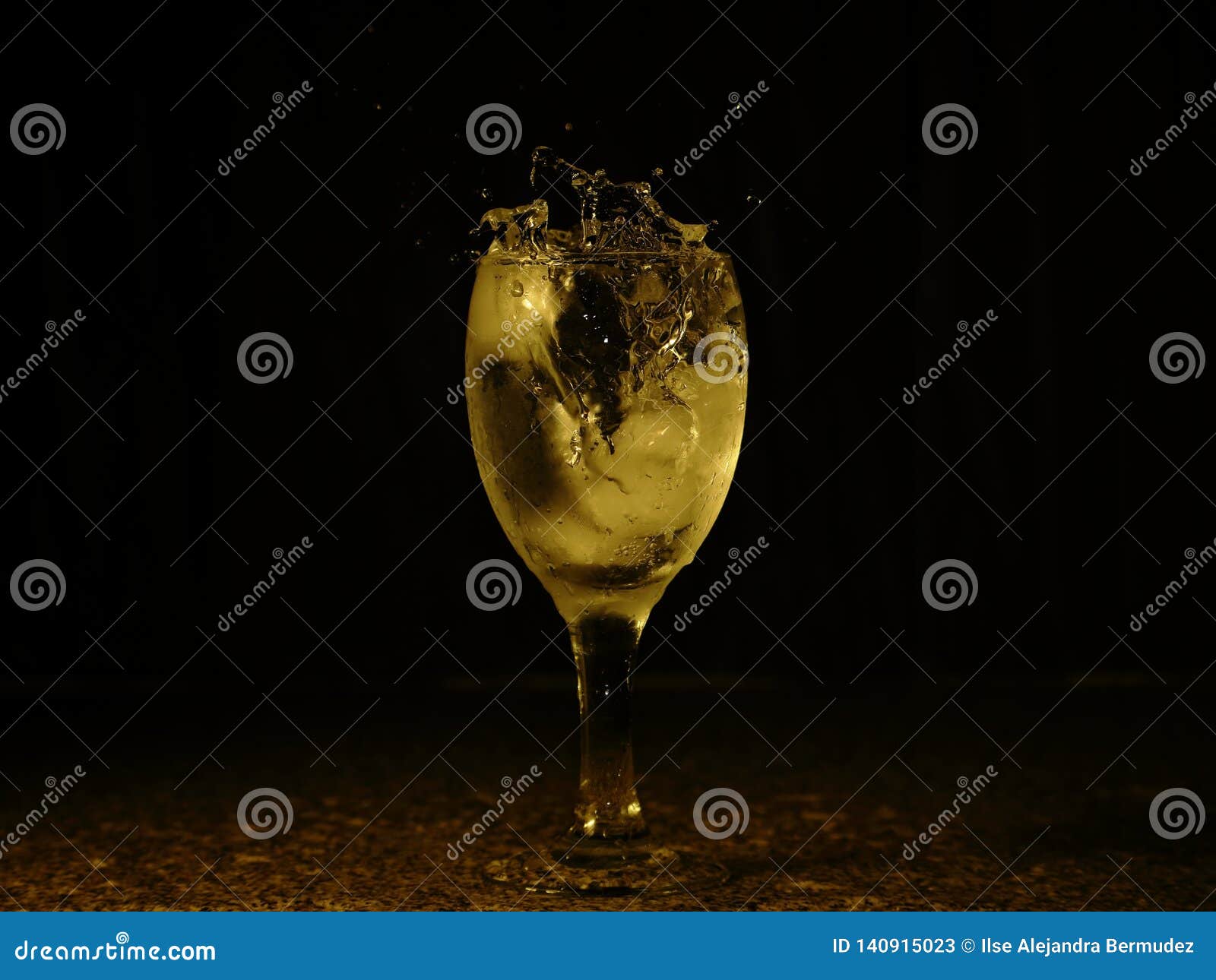 Ice Falling on a Glass with Drink that Spills and Splashes. Stock Image ...