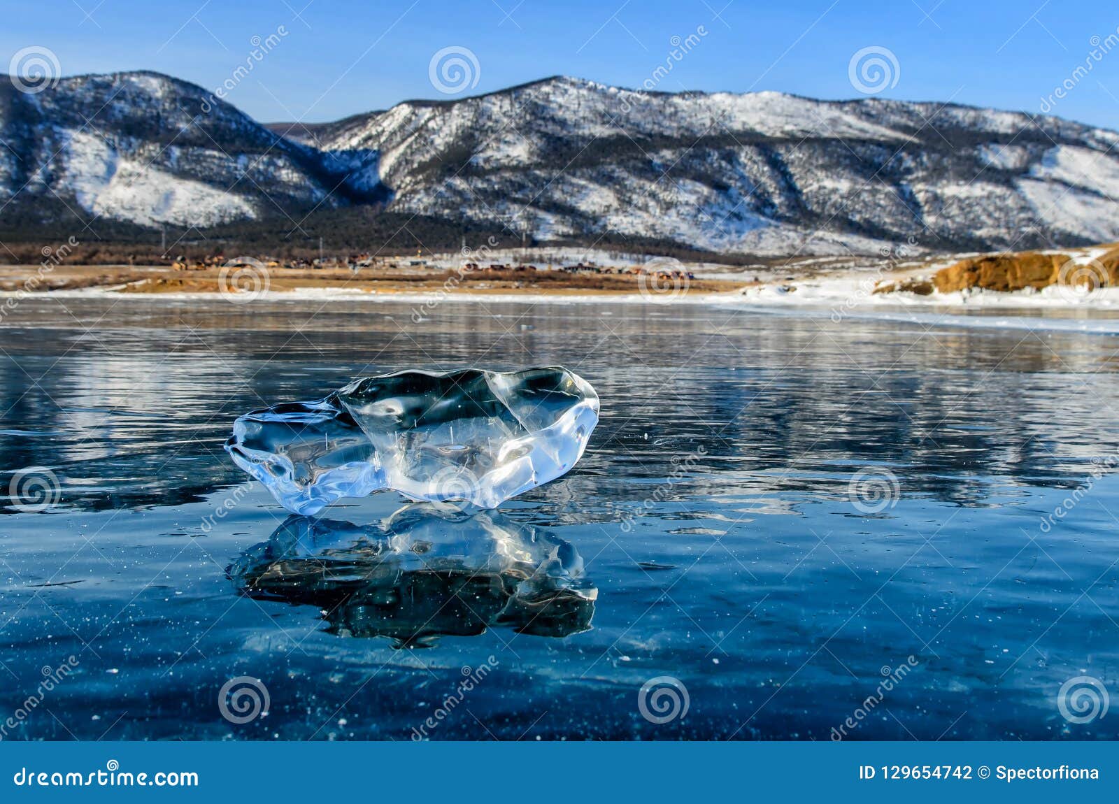 Ice Floe at Frozen Lake Surface with Reflection. Deep Cracks in the Ice ...
