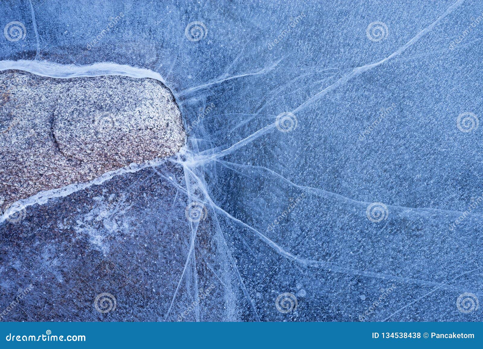 Ice Cracking Around Rock stock photo. Image of boulder - 134538438