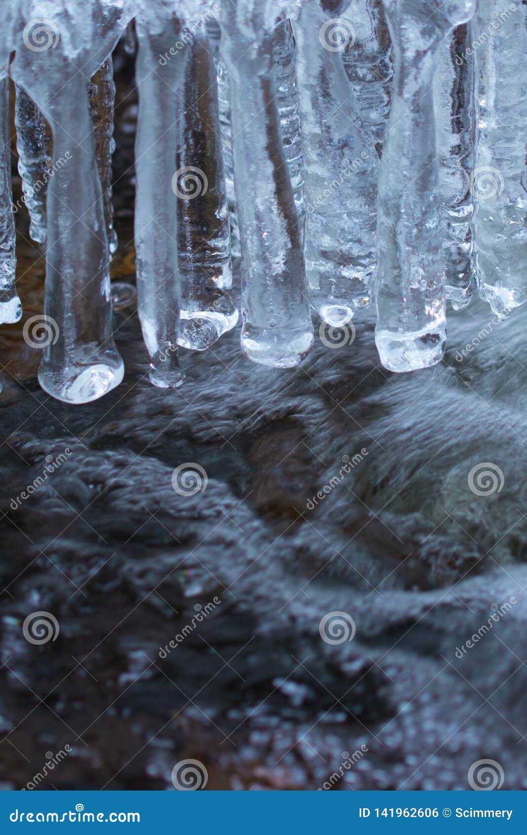 Ice, icicles in water stock photo. Image of crystal - 141962606