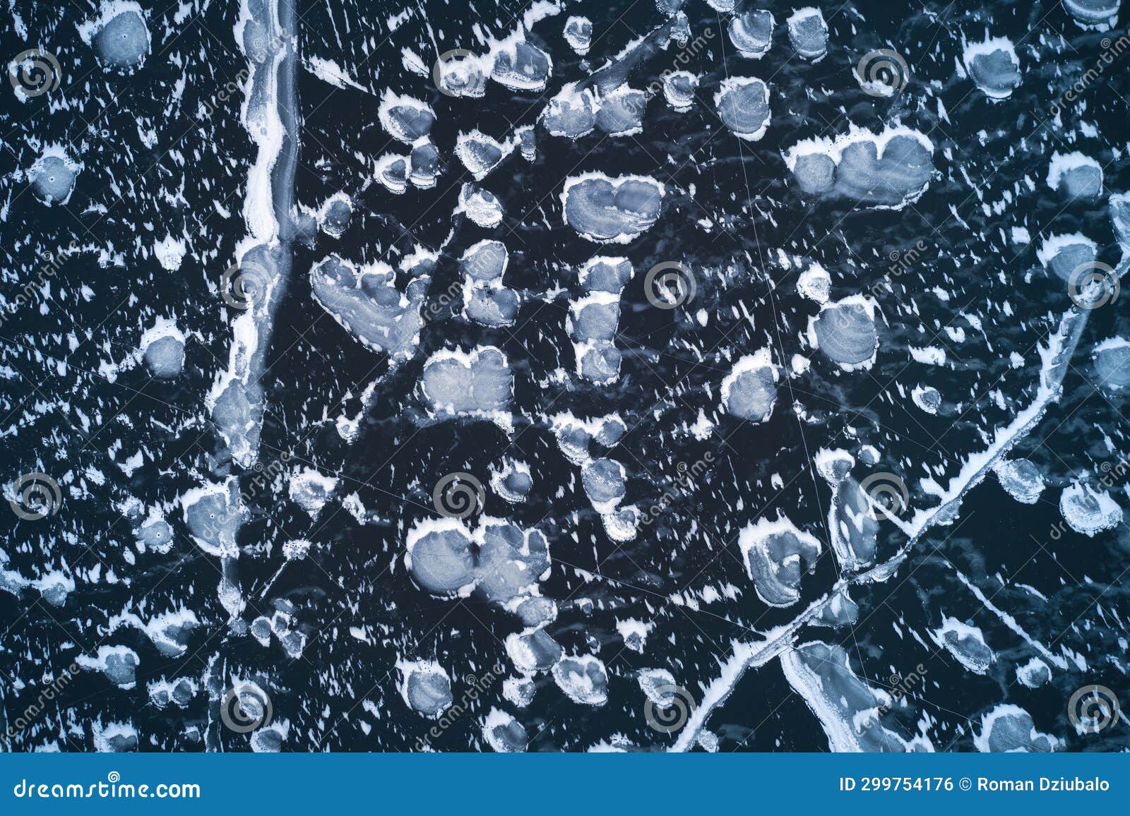 Ice Patterned Surface of Frozen Water Body in Cracks with Light Snow ...