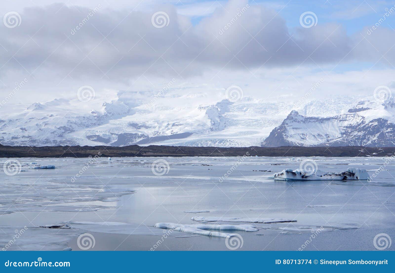 Ice Sheet on the Water with Snow Mountain Background Stock Photo ...