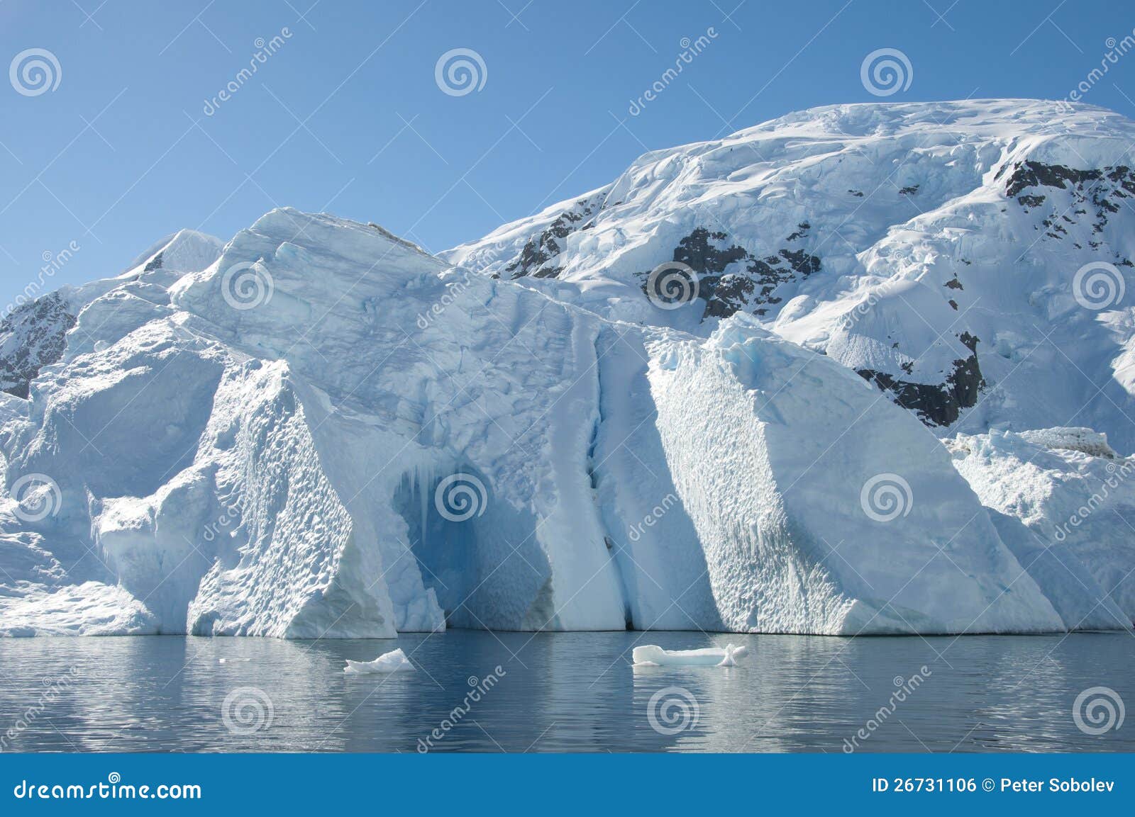 Iceberg with Cave and Mountain Behind it Stock Photo - Image of melting ...