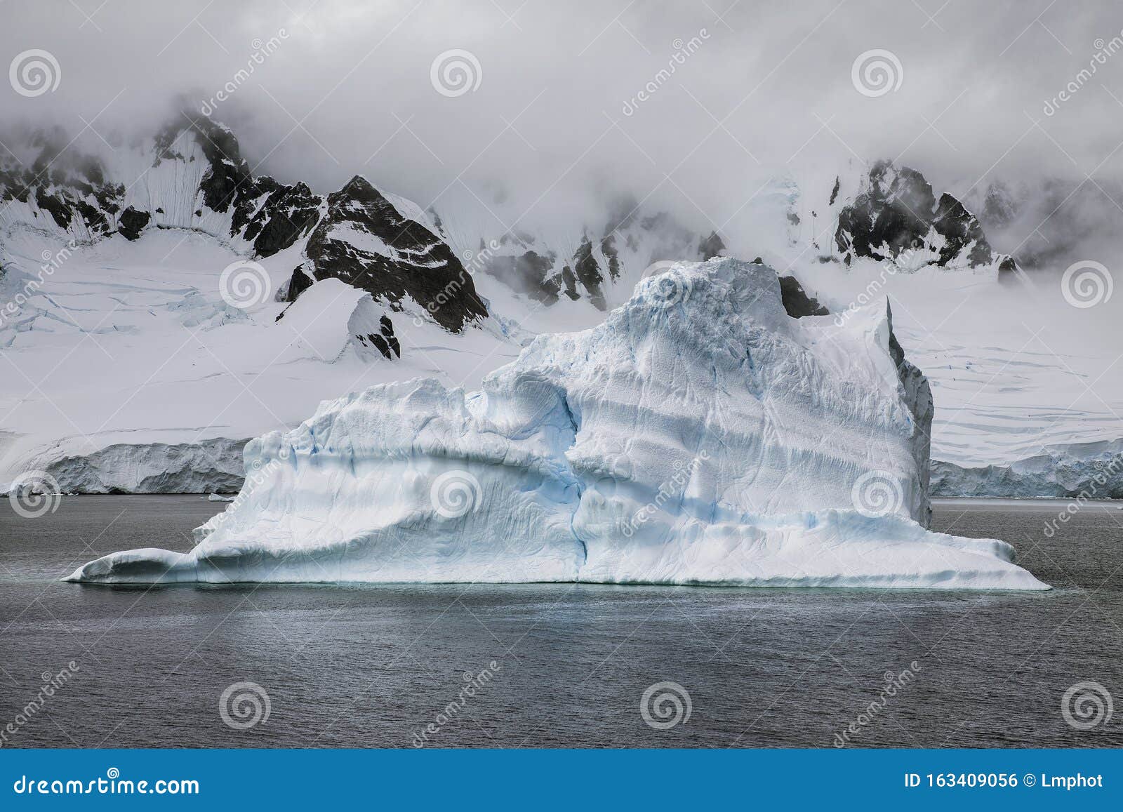 Iceberg with Mountain Backdrop, Antarctica Stock Photo - Image of ocean ...