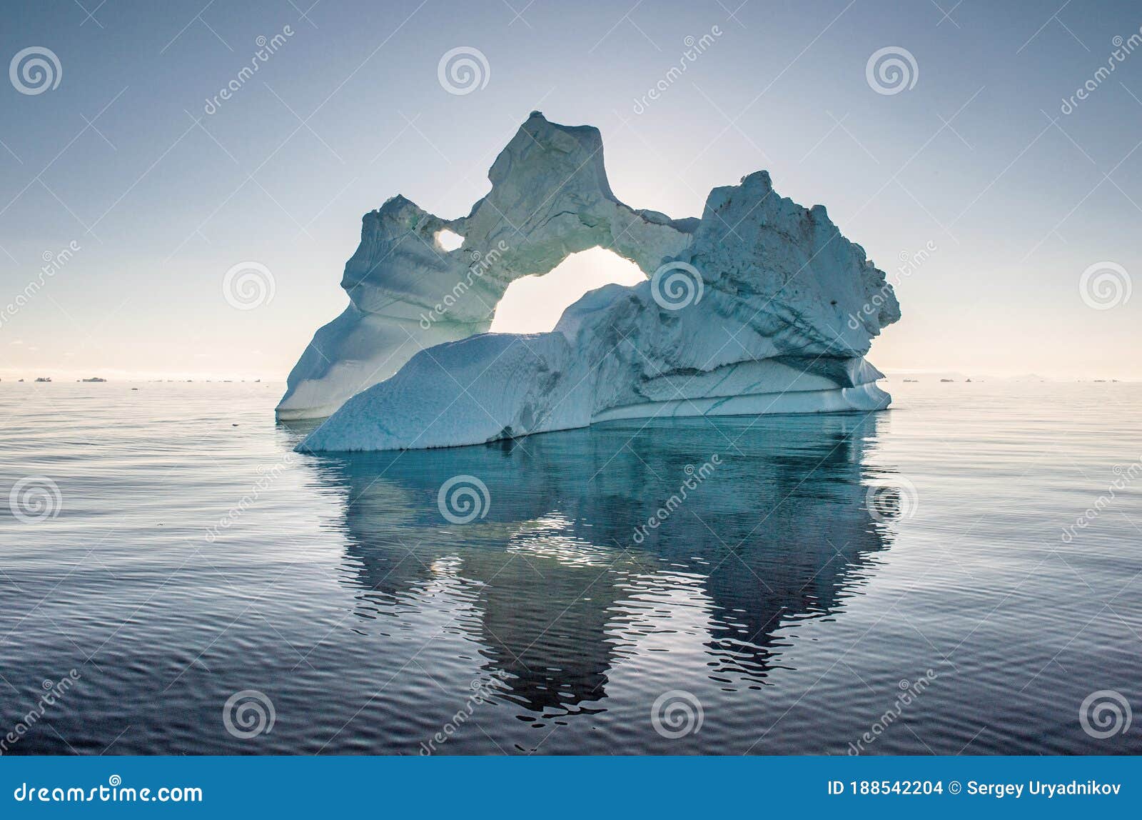 Iceberg during Sunrise with Backlight by Sunrays. Stock Photo - Image ...