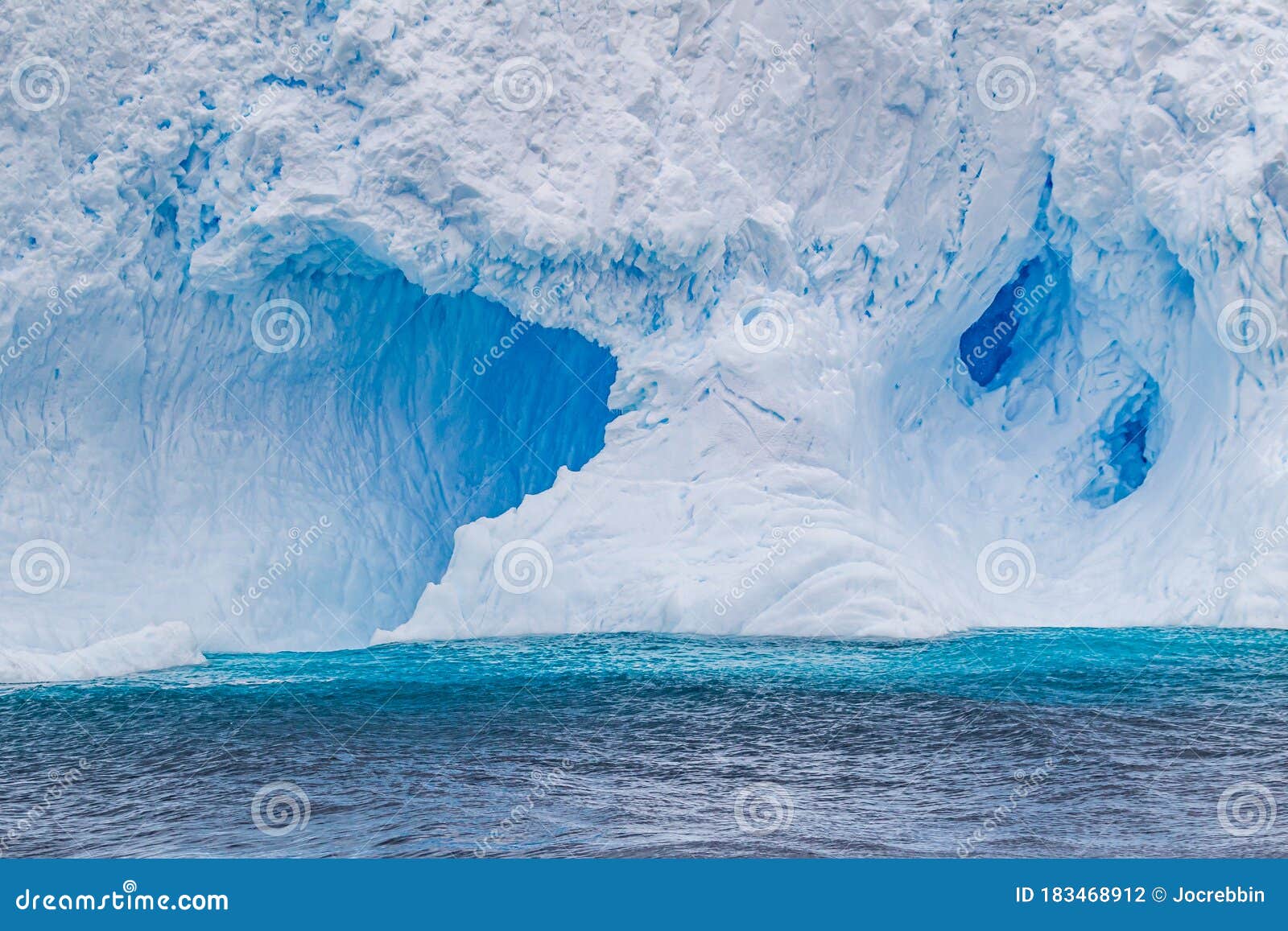 Iceberg with a Tunnel Floats Off the Coast of Antarctica Stock Photo ...