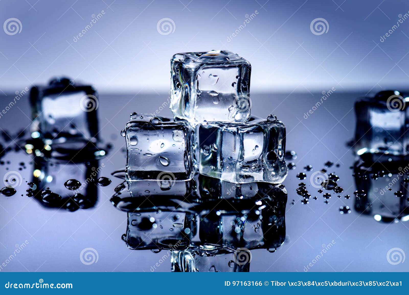 Iced Cubes Melting on a Blue Table with Reflection. Water. Melting of ...