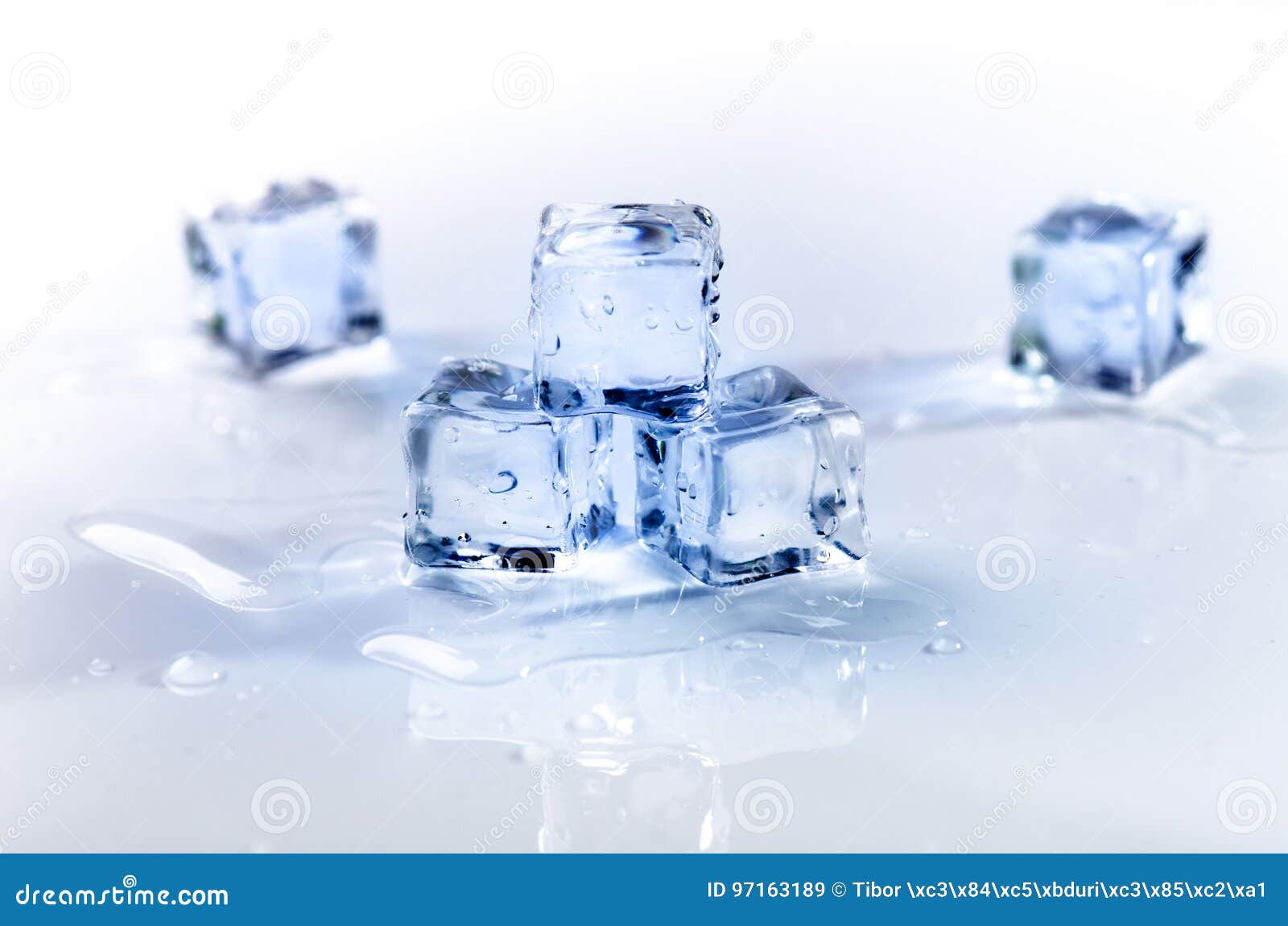 Iced Cubes Melting on a Blue Table with Reflection. Water. Melting of ...