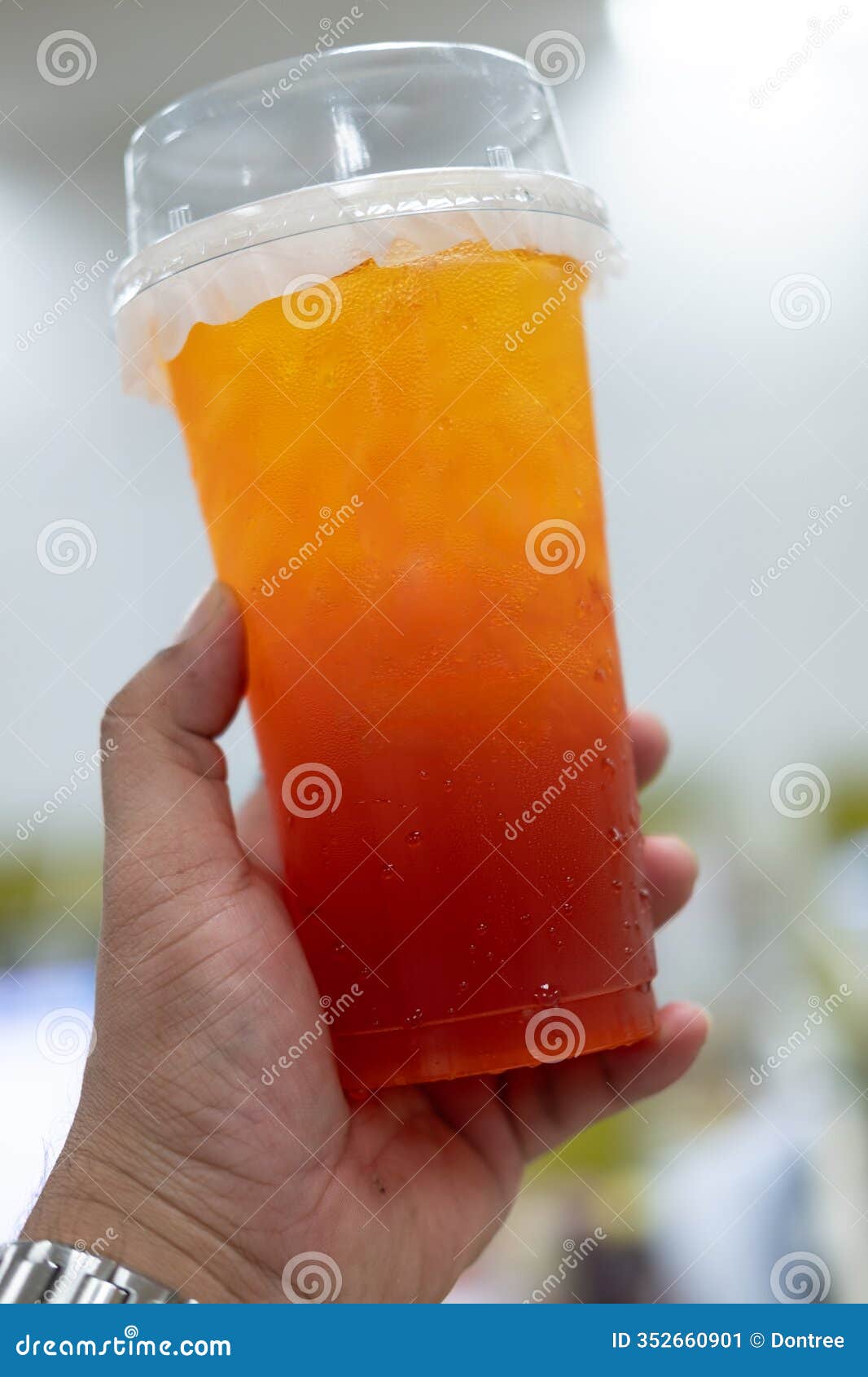 Iced Fruit Tea in Clear Plastic Cup on Hand Stock Image - Image of ...