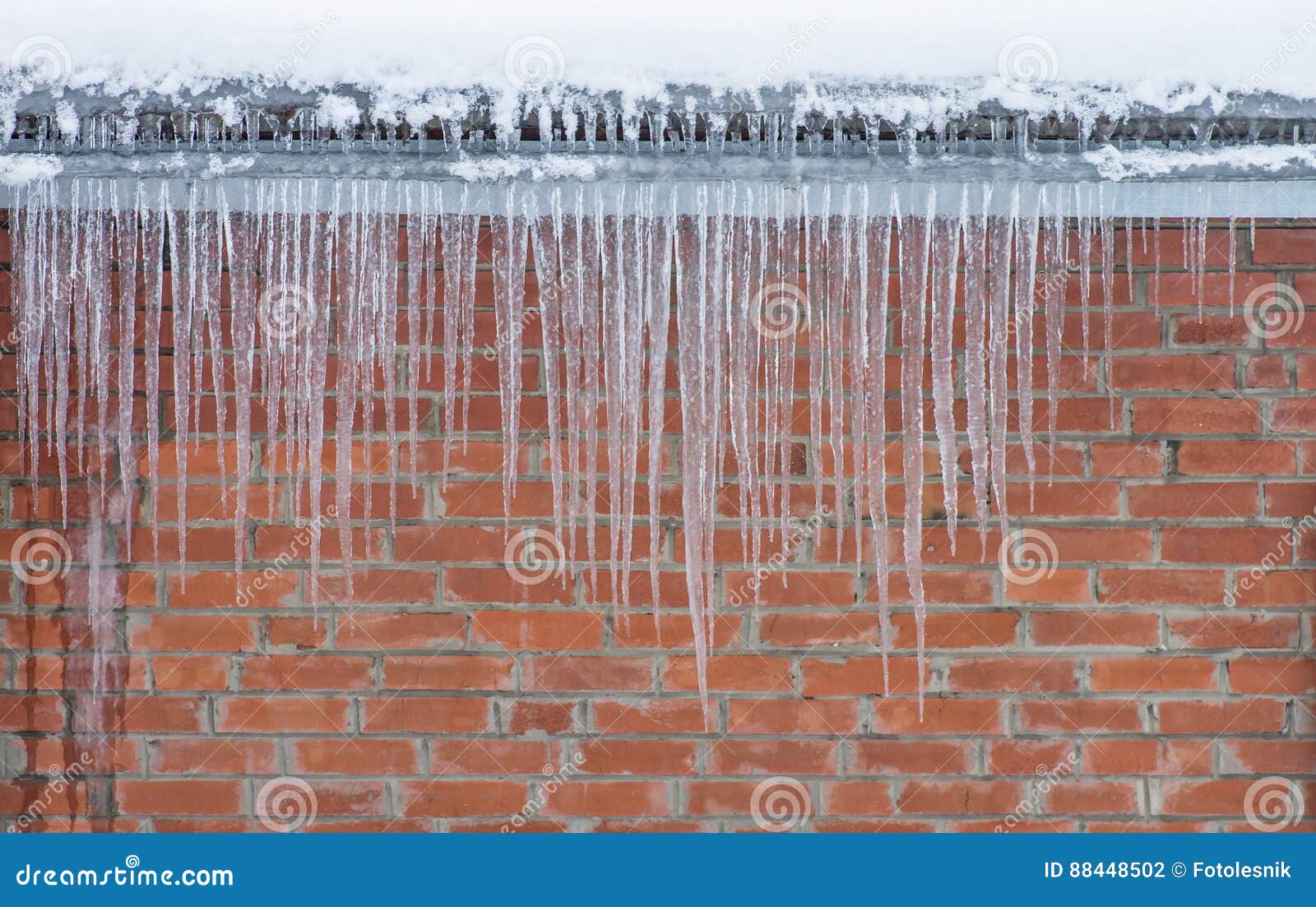 Icicles on a Background of Red Brick Wall Stock Photo - Image of white ...