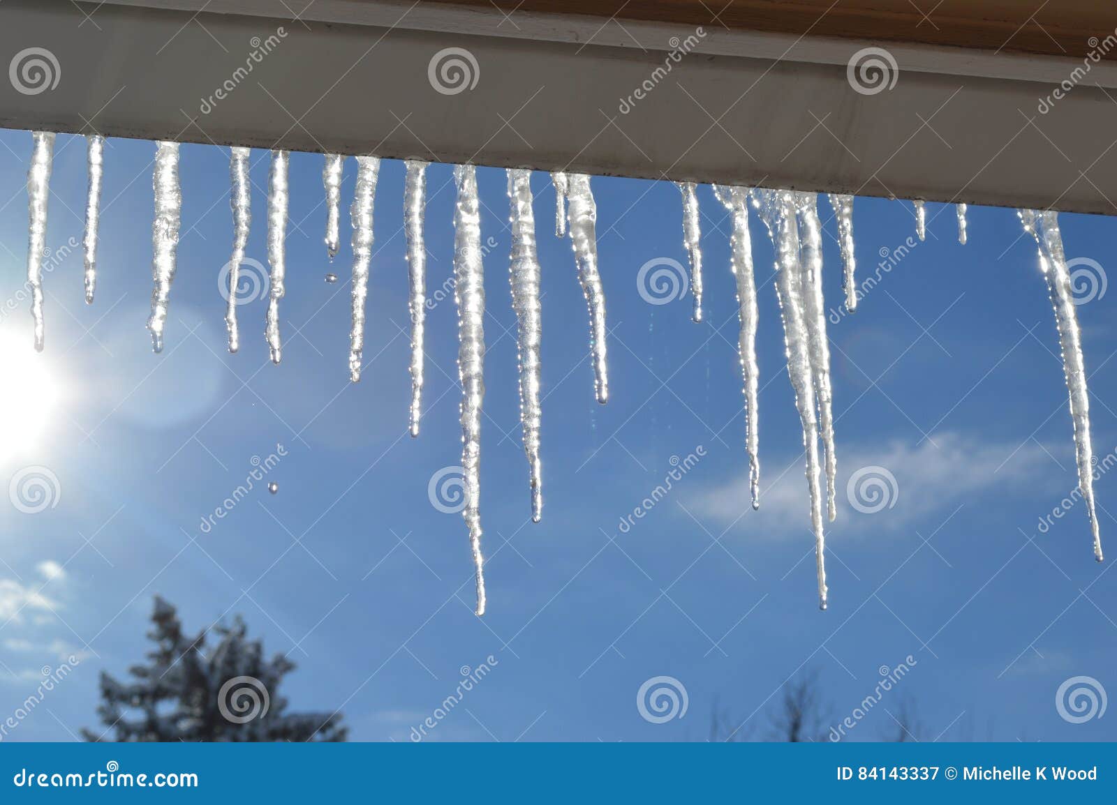 Icicles glisten in the sun stock image. Image of outside - 84143337