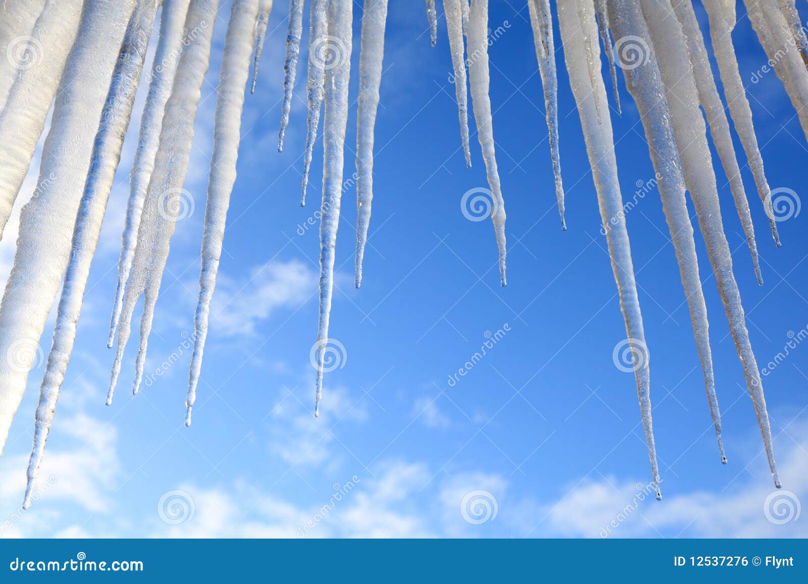Icicles Hanging Against a Blue Sky Stock Photo - Image of close ...