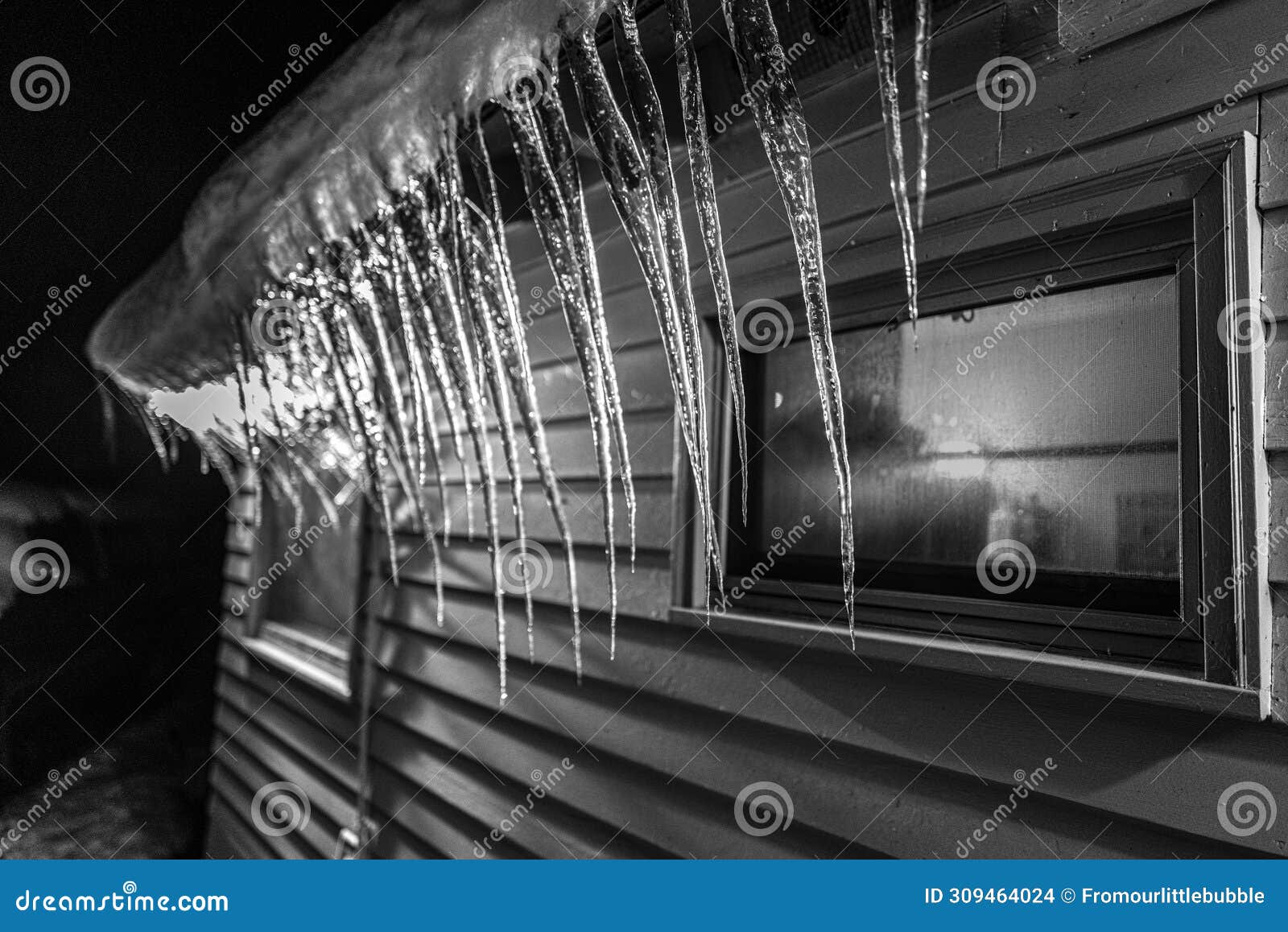 Icicles Hanging from an Eave at Night Stock Photo - Image of porch ...