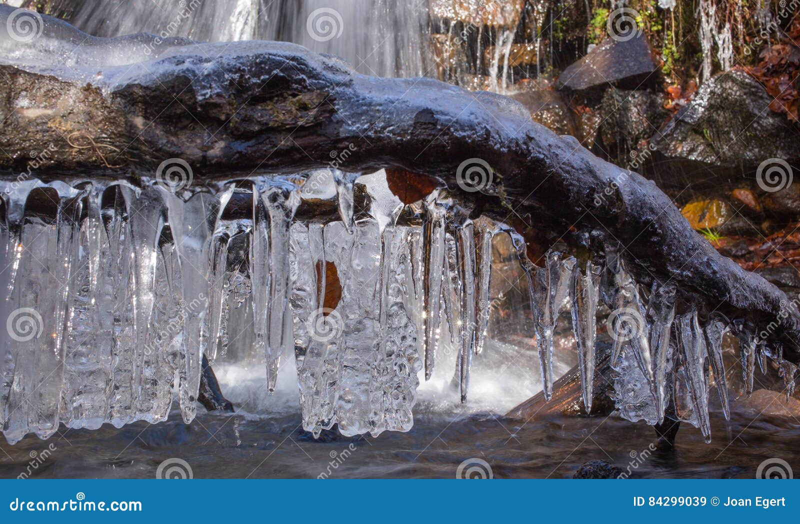Icicles on log over water stock image. Image of christmas - 84299039