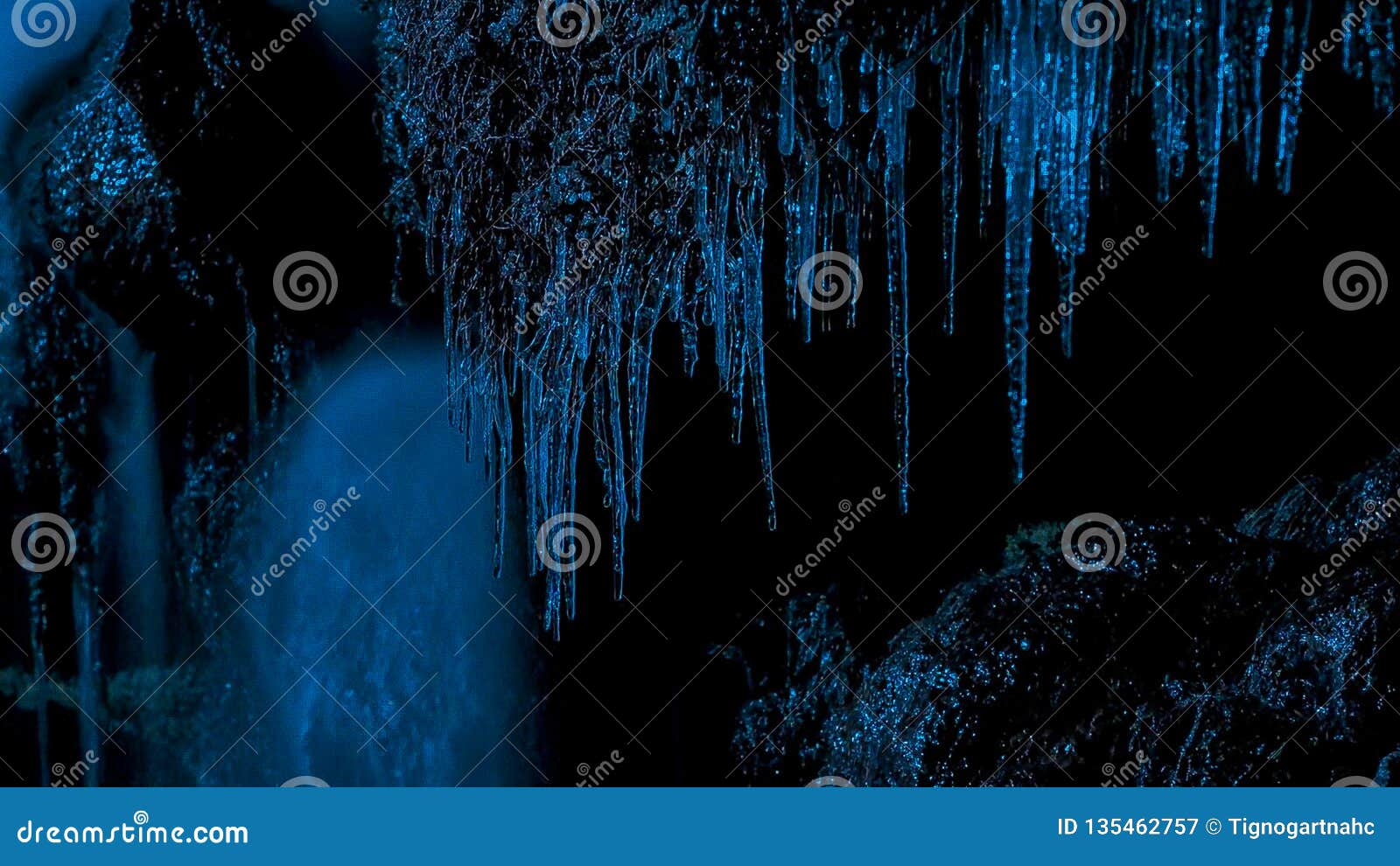 Icicles at Night Against the Dark of Forest and Winter Twilight Stock ...
