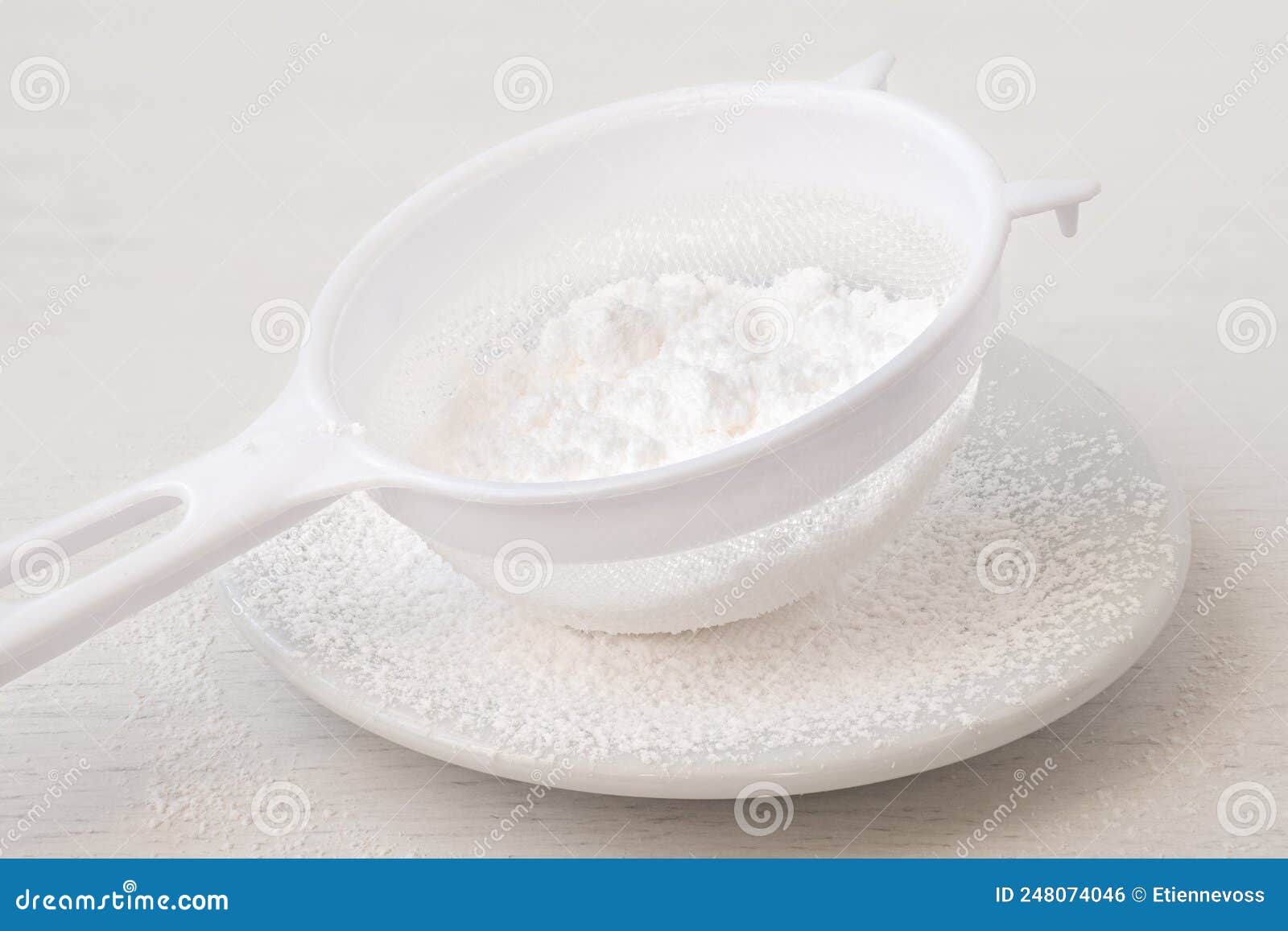 Icing Sugar in a Plastic Sieve on Top of White Ceramic Plate Stock ...