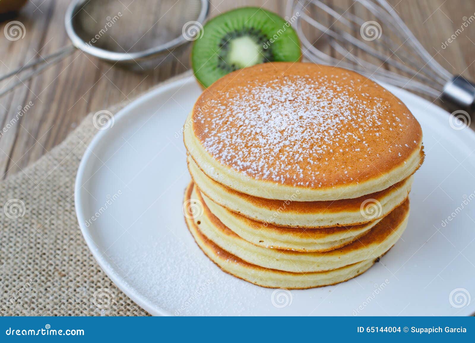 Icing Sugar On Stack Of Pancake On White Plate And Sackcloth Wit Stock ...
