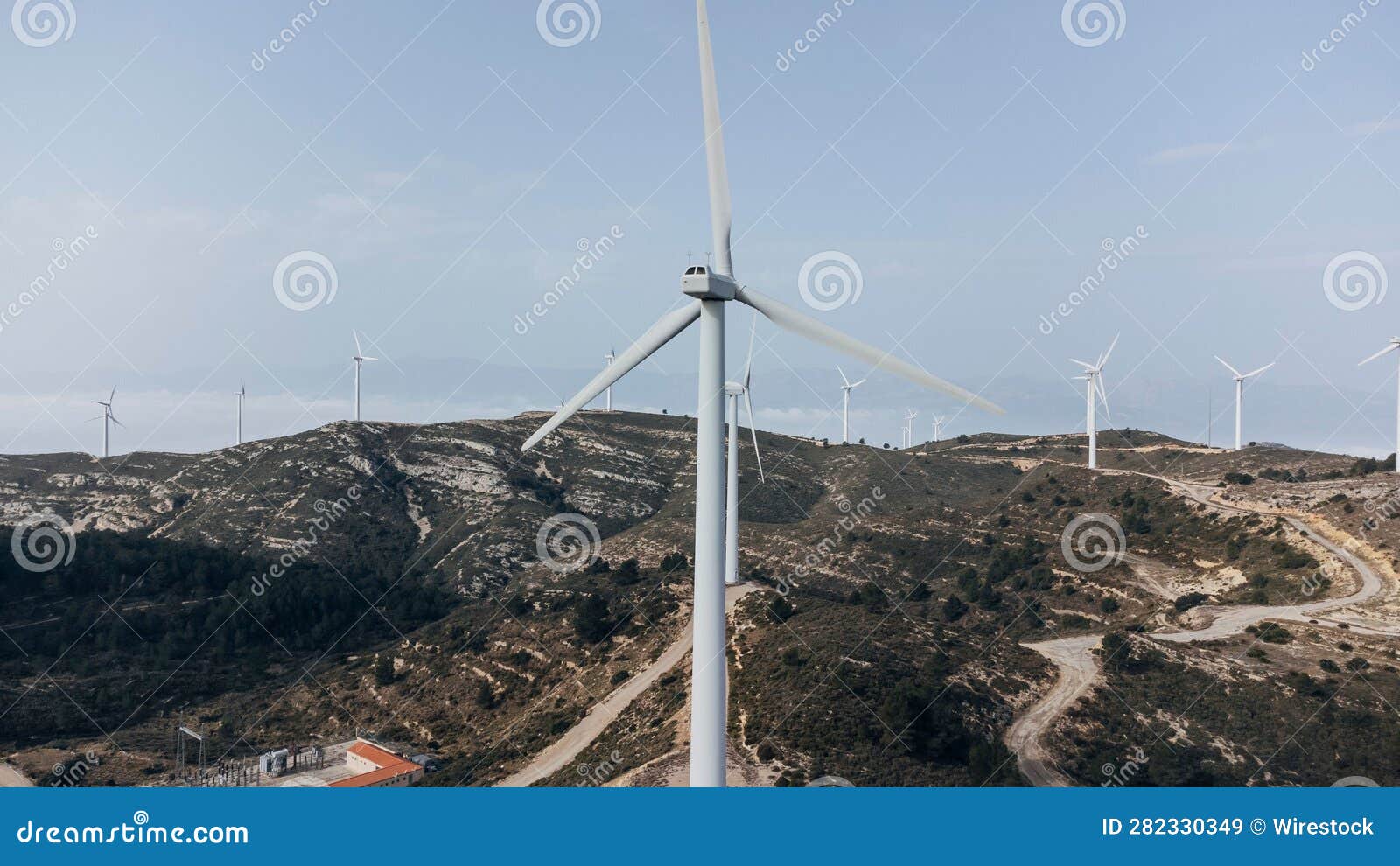 Iconic Windmill Sitting Atop a Grass-covered Hillside in a Rural ...