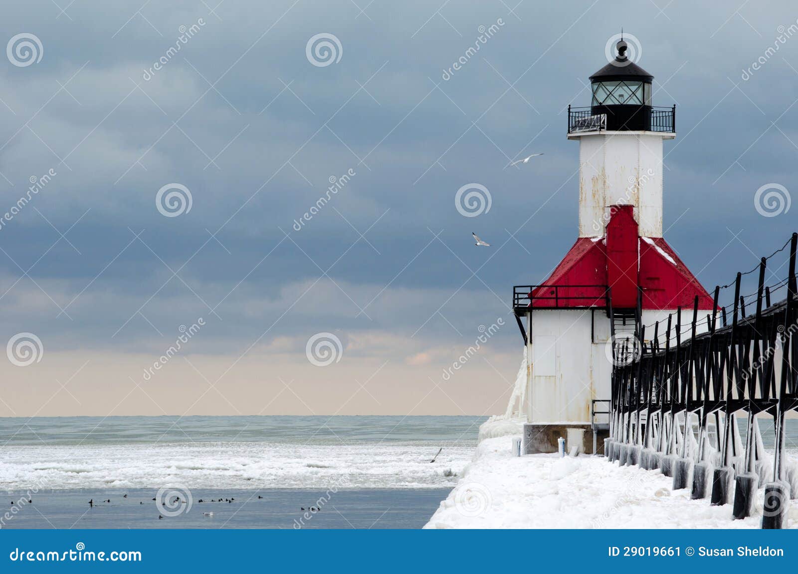 Icy lighthouse and birds stock image. Image of white - 29019661