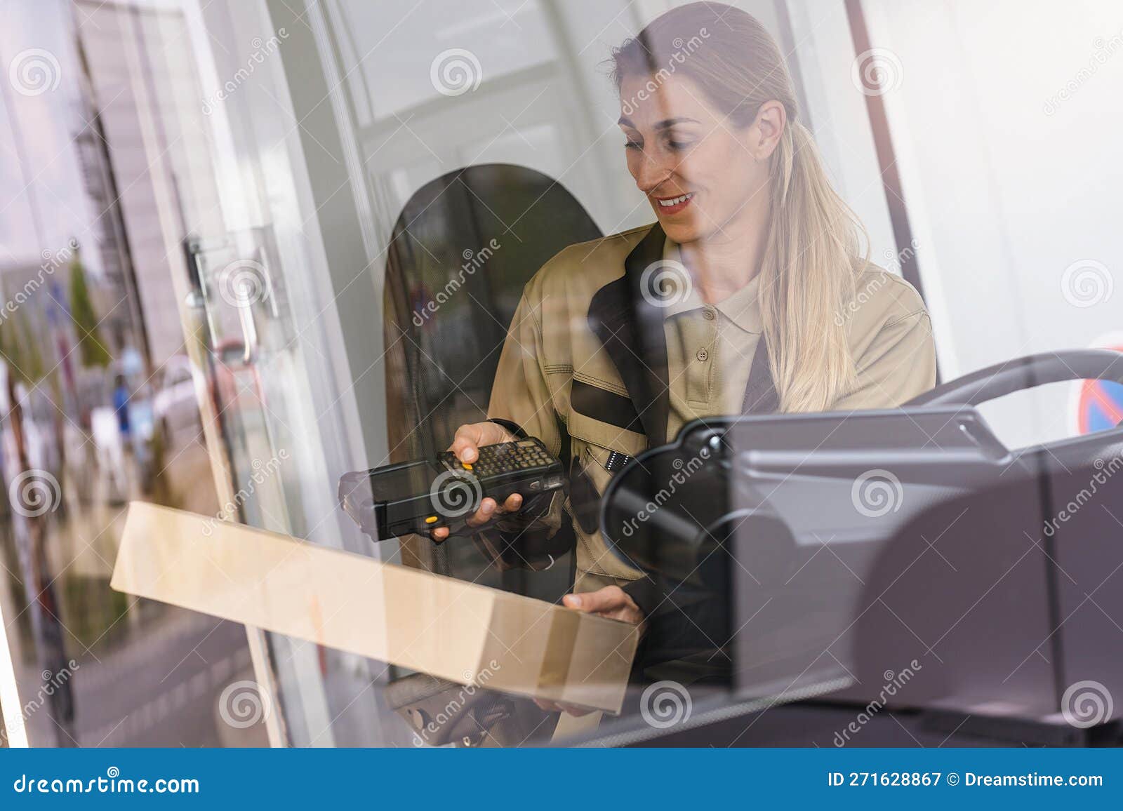 Female Delivery Driver Using Barcode Scanner Checking Pacel in a Van in ...
