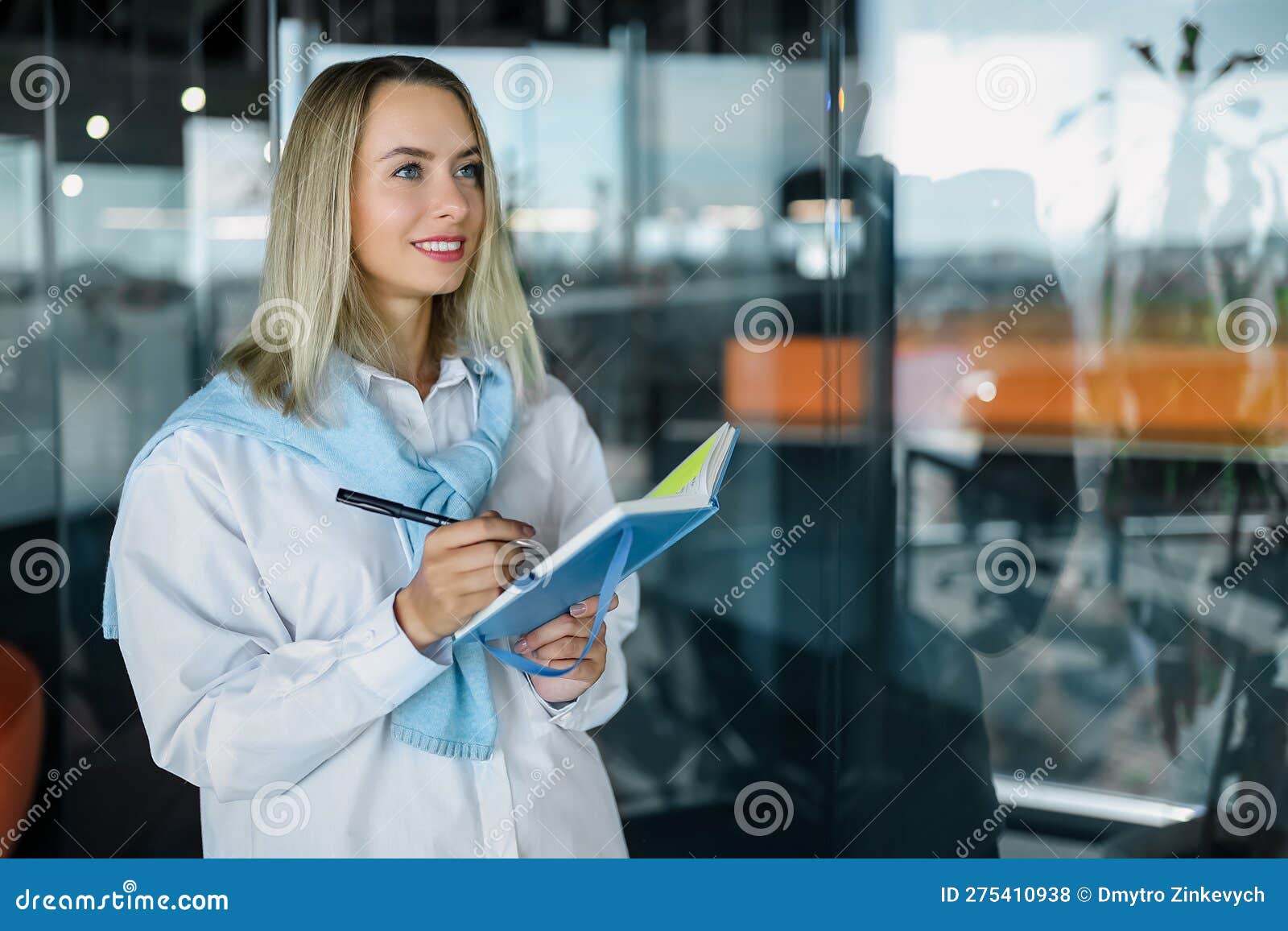 Blonde Smiling Woman Making Notes into a Notebook Stock Photo - Image ...
