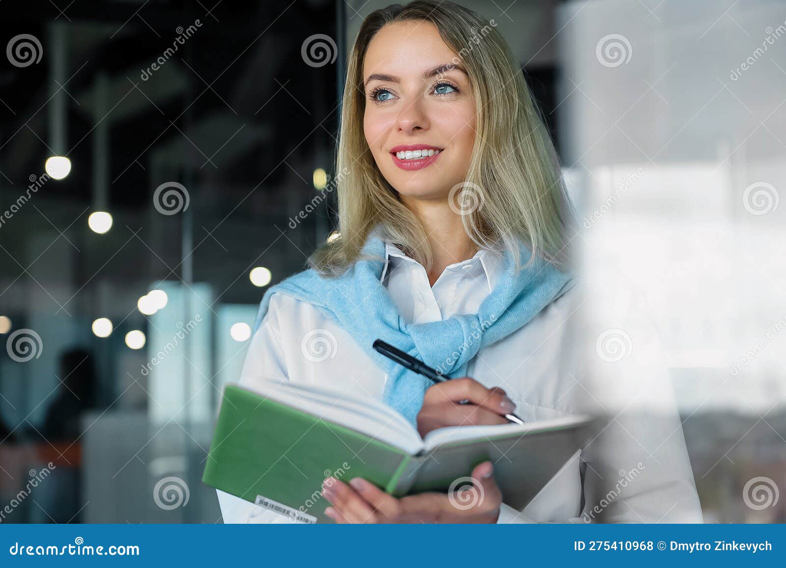 Blonde Smiling Woman Making Notes into a Notebook Stock Photo - Image ...