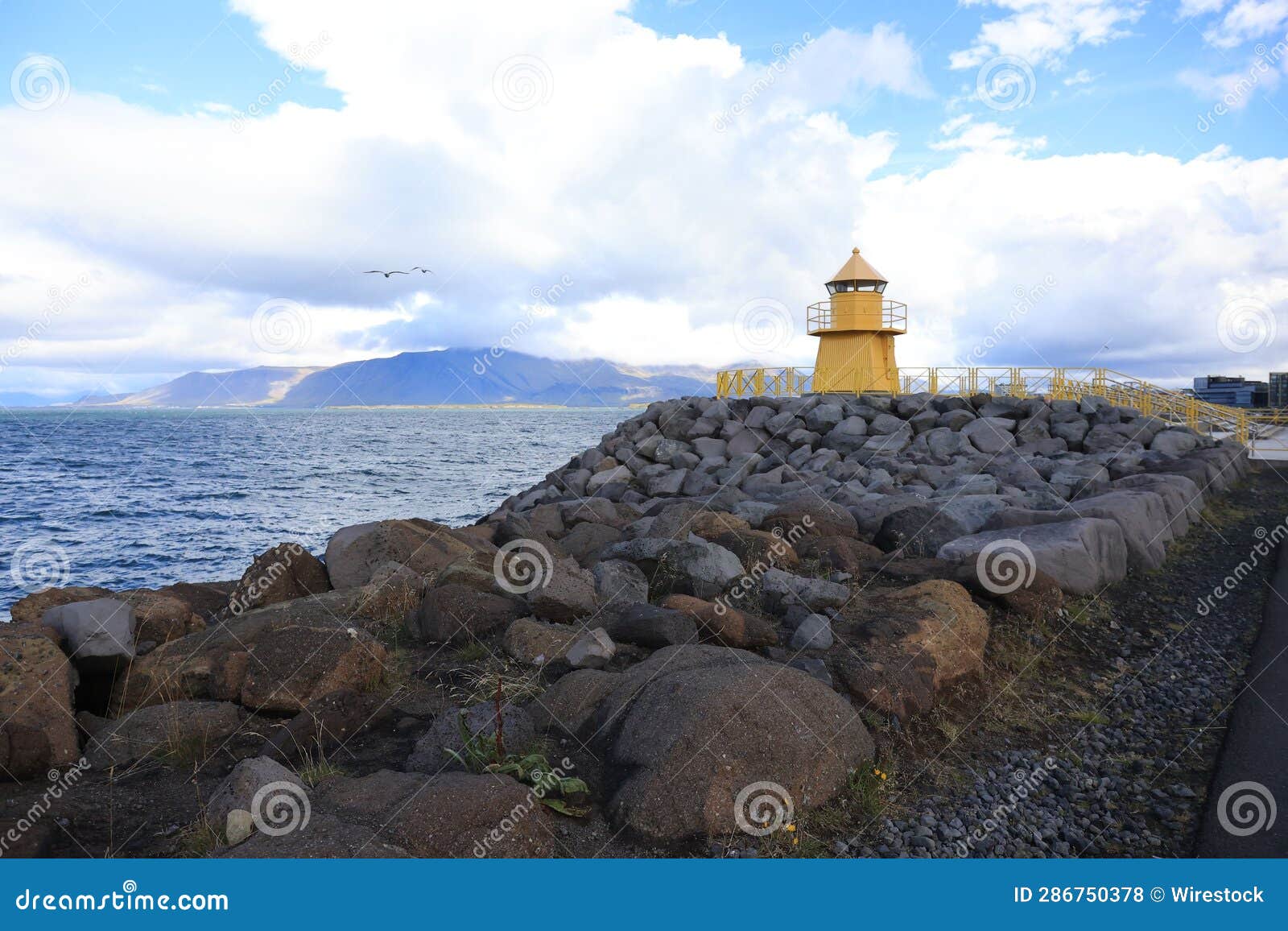 Idyllic Scene of a Majestic Yellow Lighthouse on the Shore Stock Photo ...